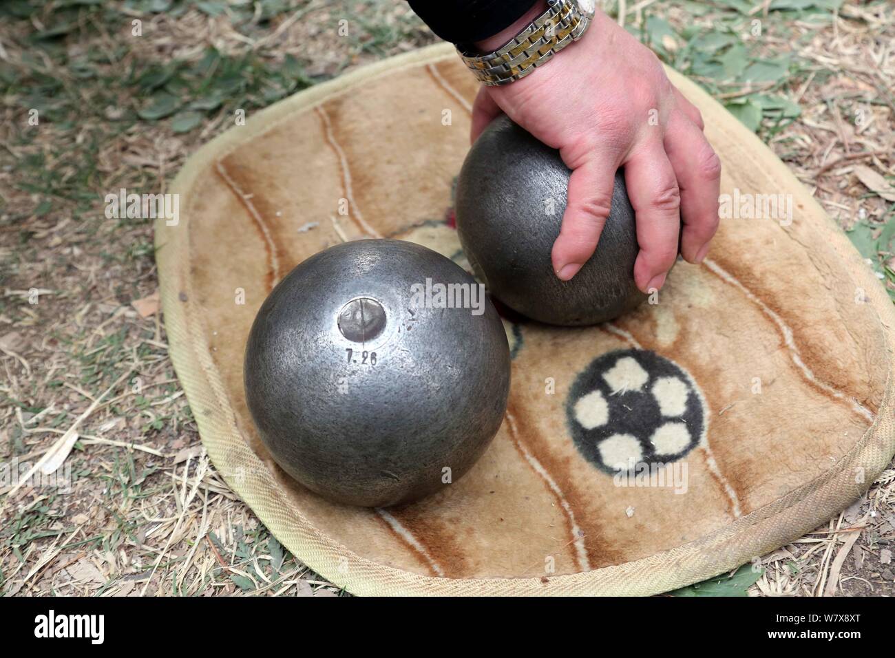 61-year-old Chinese man Piao Yingmin shows his iron balls at a park in ...