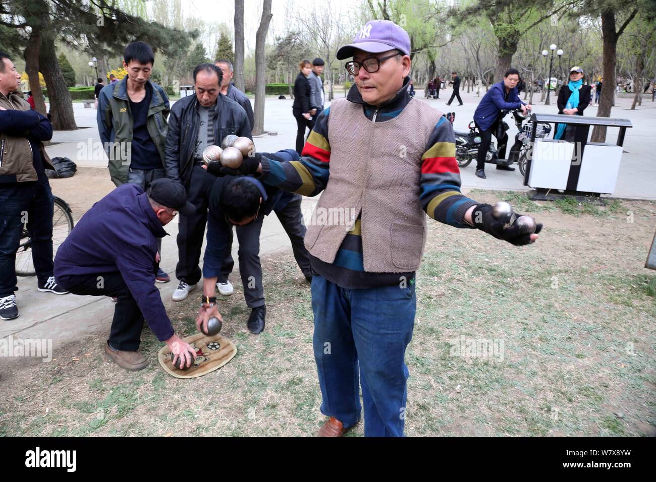 61-year-old Chinese man Piao Yingmin plays iron balls at a park in ...
