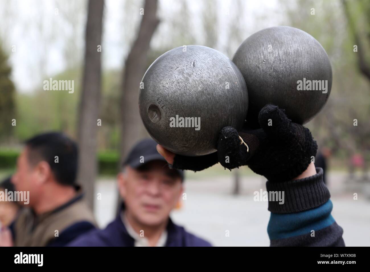61-year-old Chinese man Piao Yingmin shows his iron balls at a park in ...