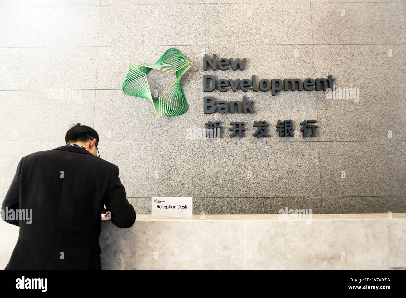 --FILE--A Chinese employee is seen at an office building of the BRICS ...