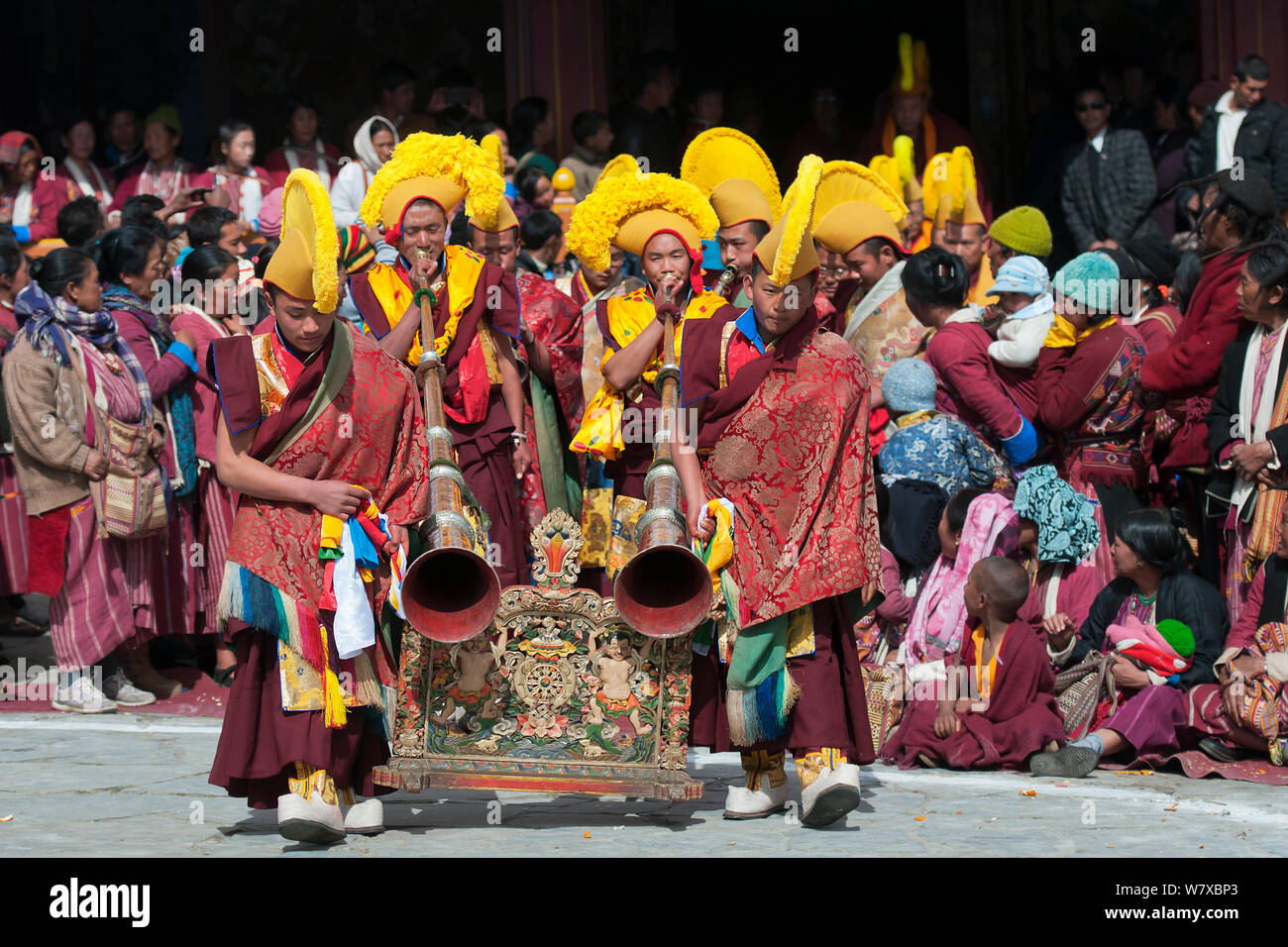 Buddhist monks playing long trumpets (Lawa) during Torgya festival ...