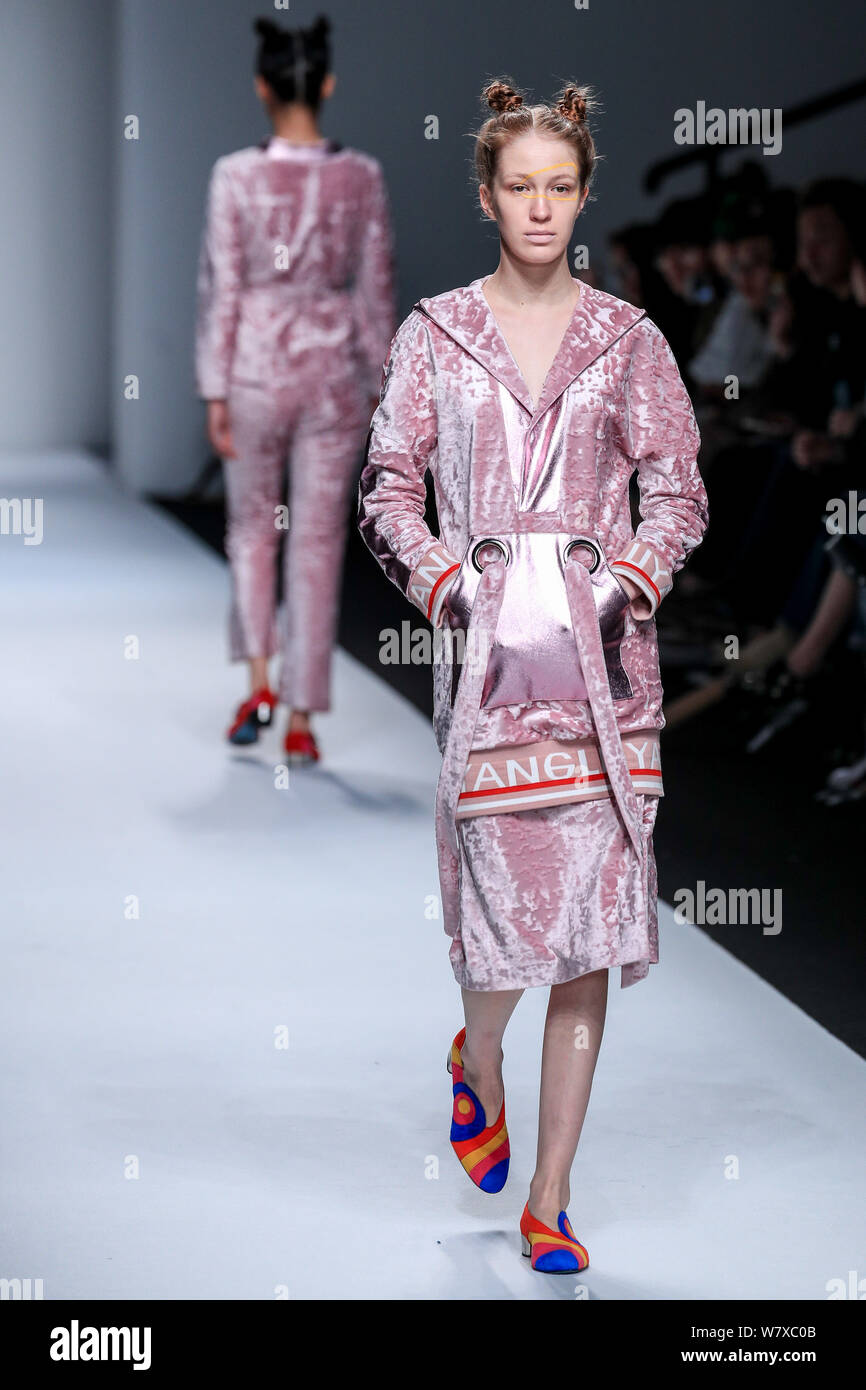 A model displays a new creation at the fashion show of LU YANG BY LANG ...