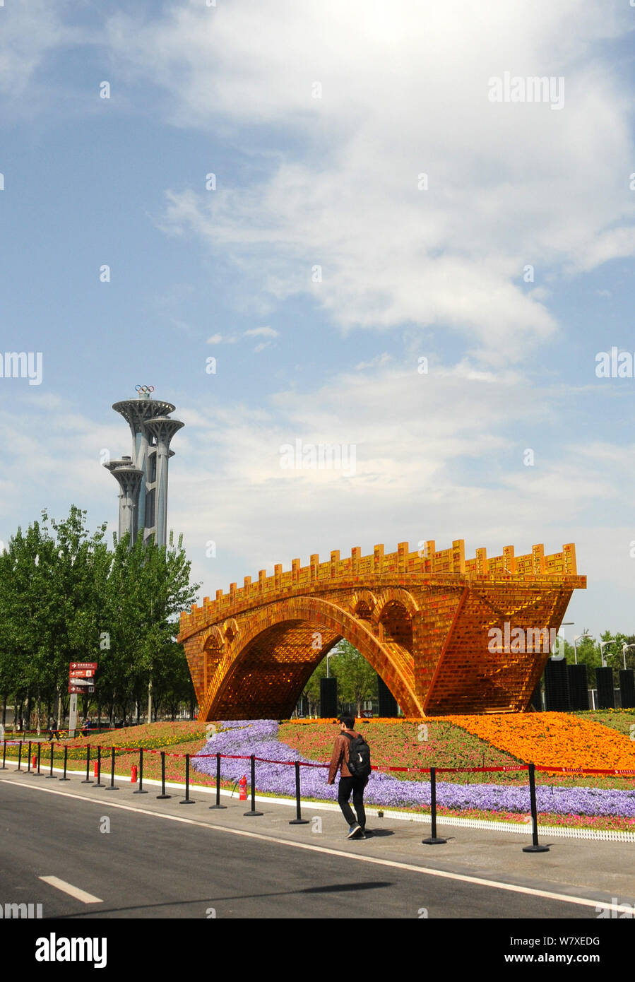 A pedestrian walks past the newly built "Silk Road Golden Bridge" at ...