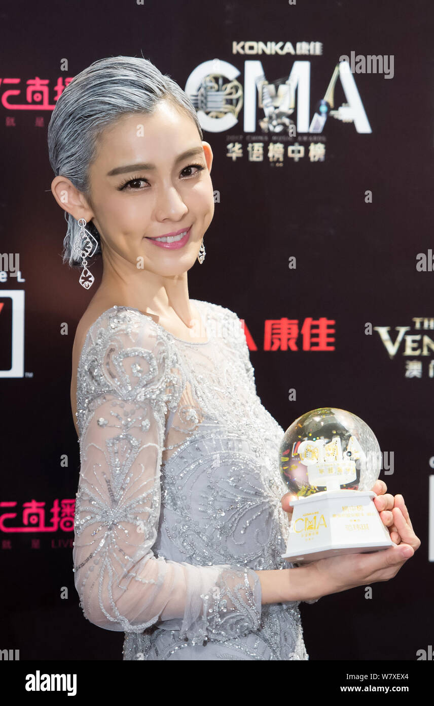 Taiwanese singer and actress Christine Fan poses with her trophies ...