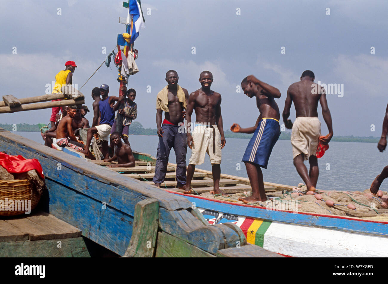 Local cargo and passenger vessel with crew, Port Loko, Sierra Leone ...