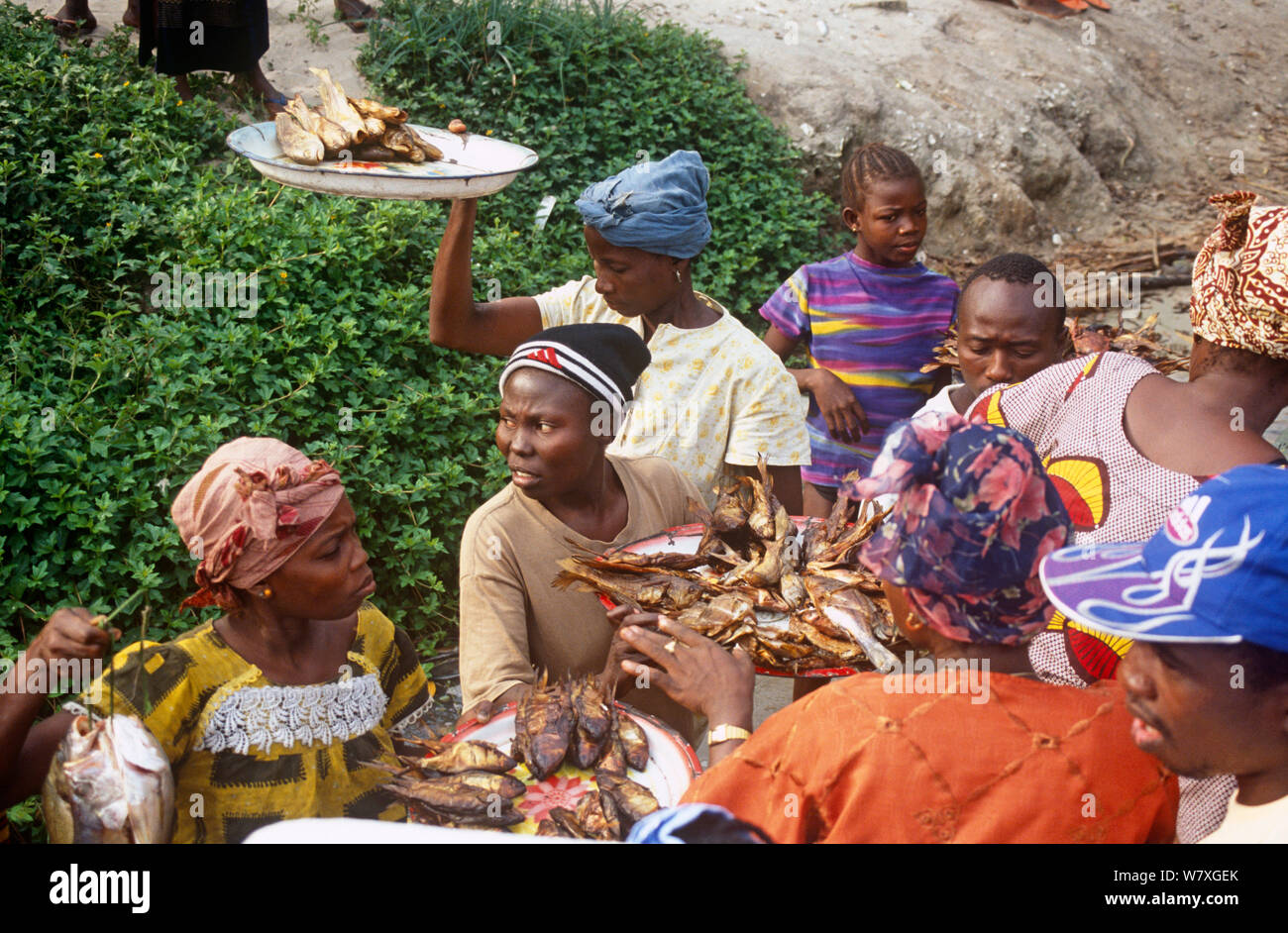 Villagers selling smoked fish and crabs, Sherbro island, Sierra Leone ...