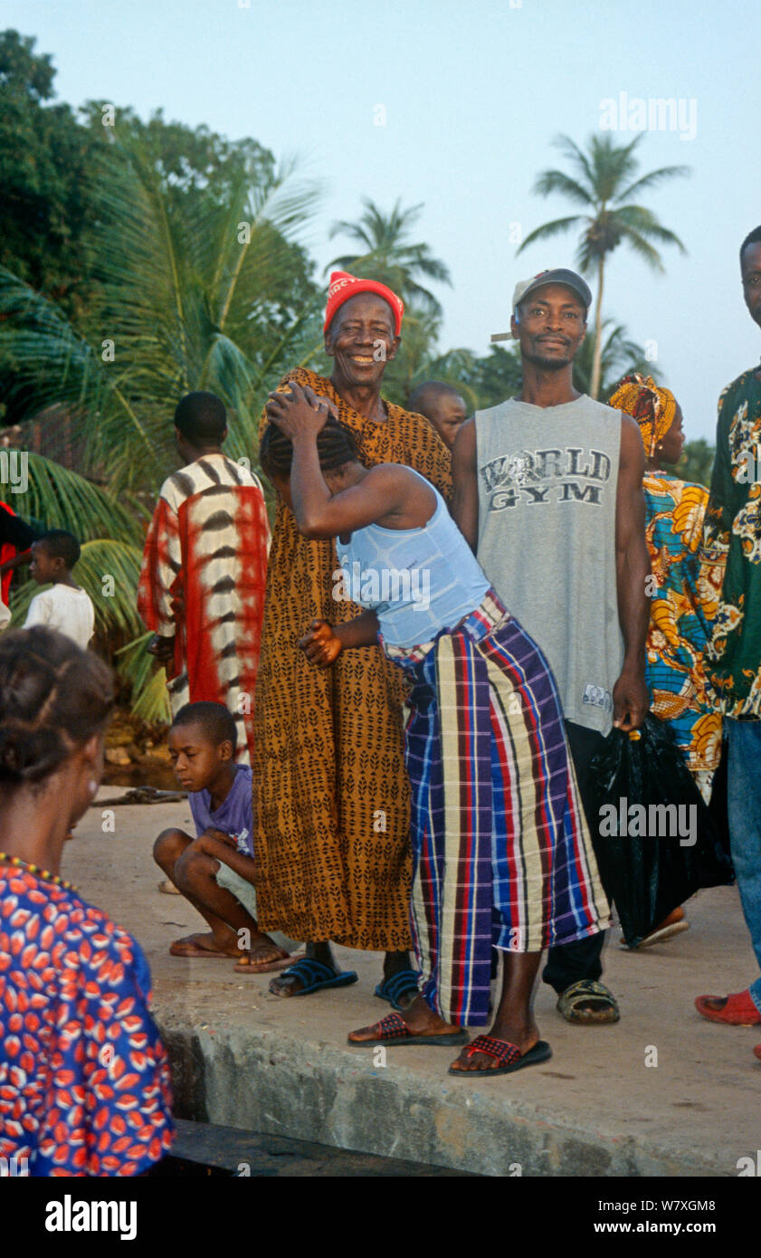 Villagers waiting for river transport, Sherbro Island, Sierra Leone ...