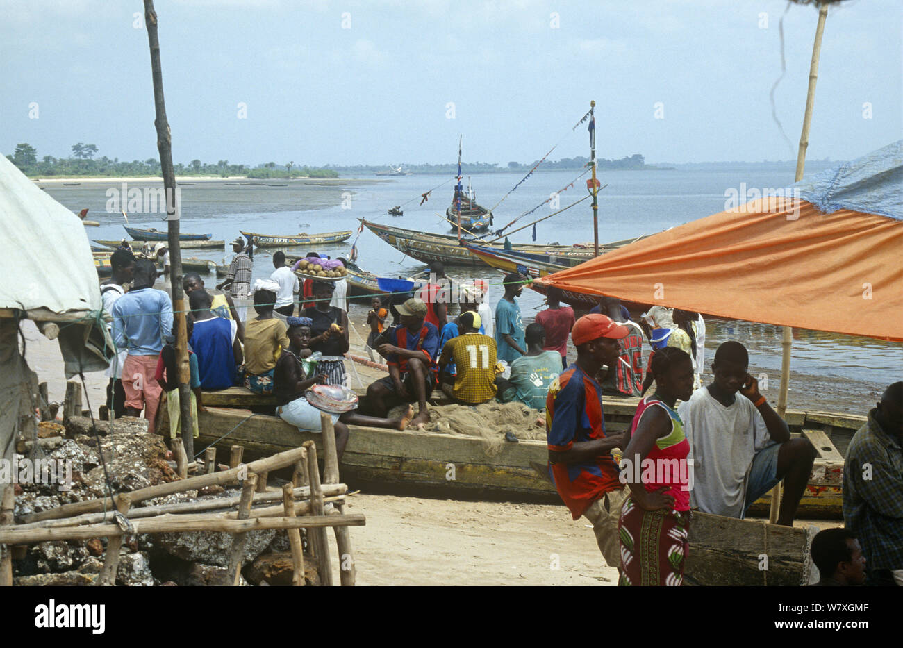 Local people and boats at trading port, Sherbro Island, Sierra Leone ...