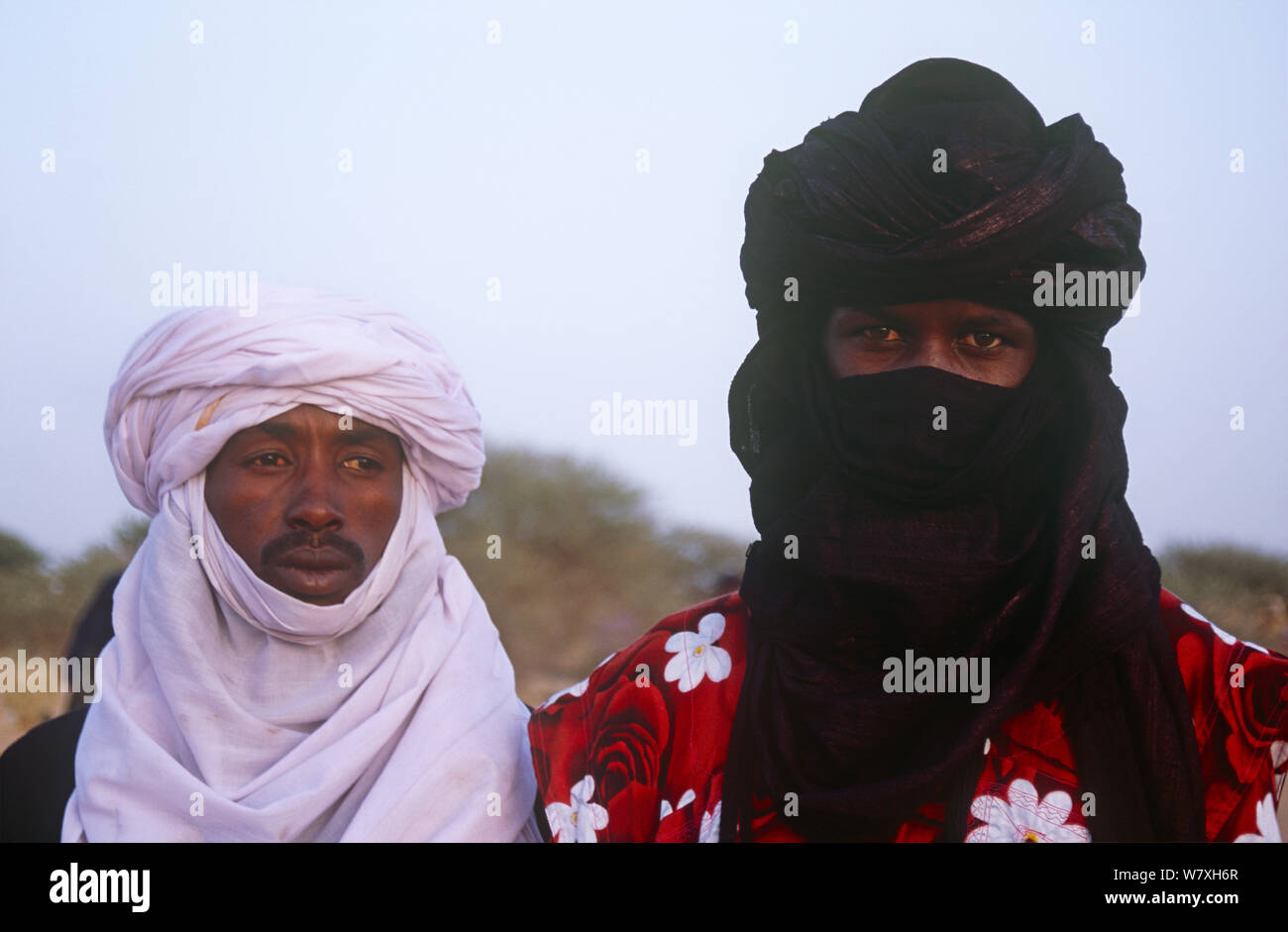 Two men, one with covered face, spectating at traditional Peul / Fula ...