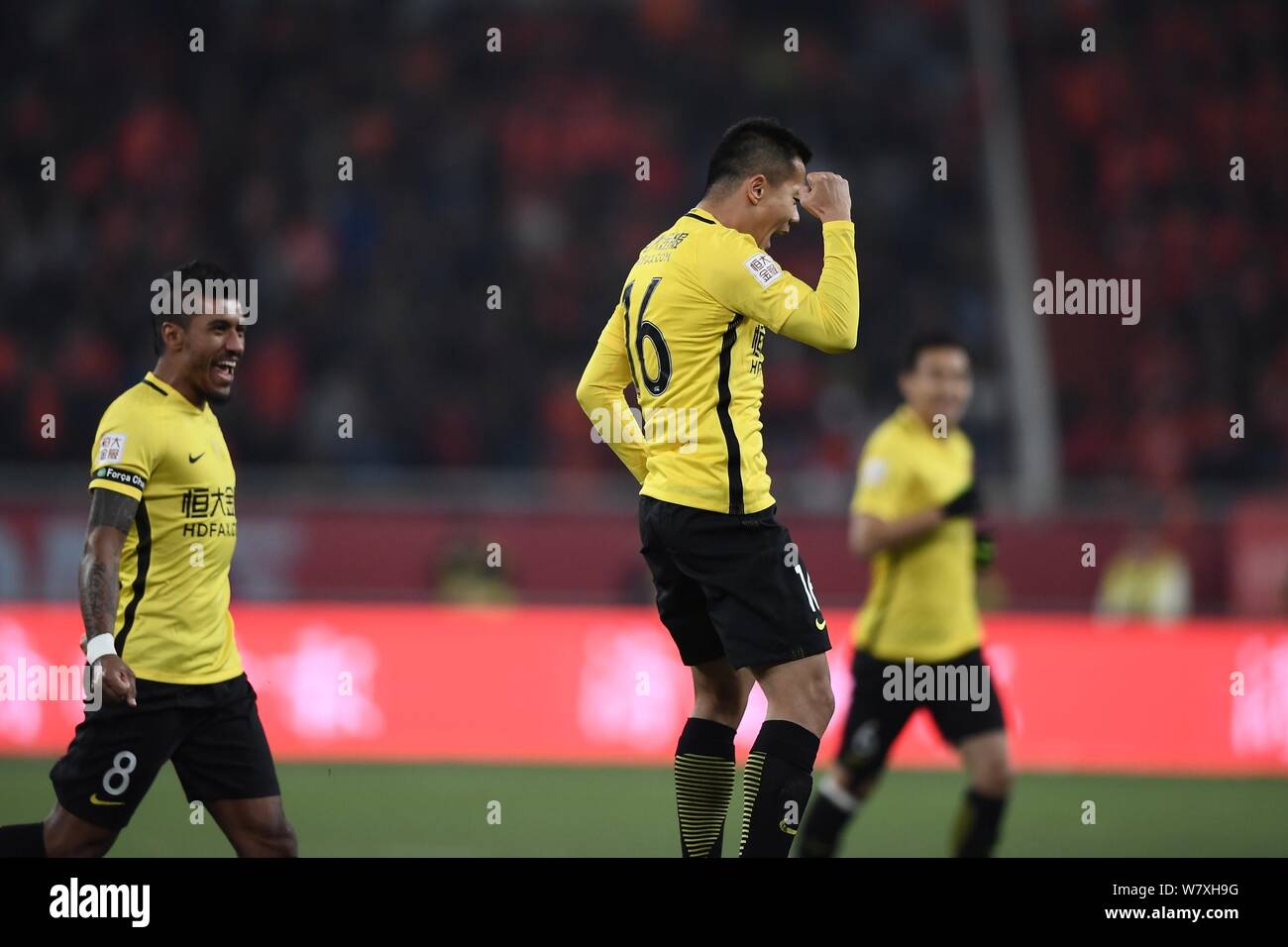Brazilian football player Paulinho of Guangzhou Evergrande, left, poses ...