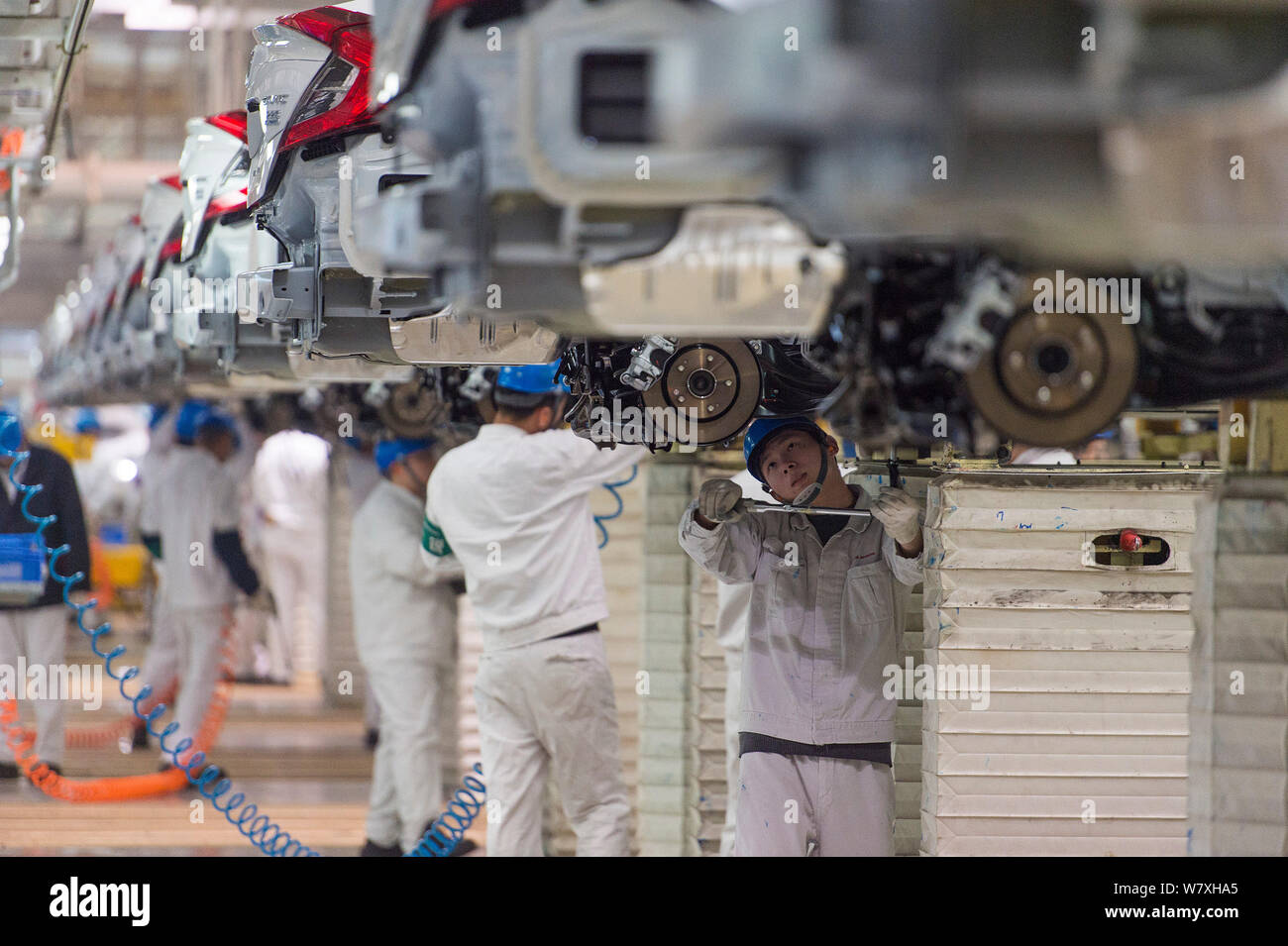 --FILE--Chinese workers assemble cars on the assembly line at an auto ...