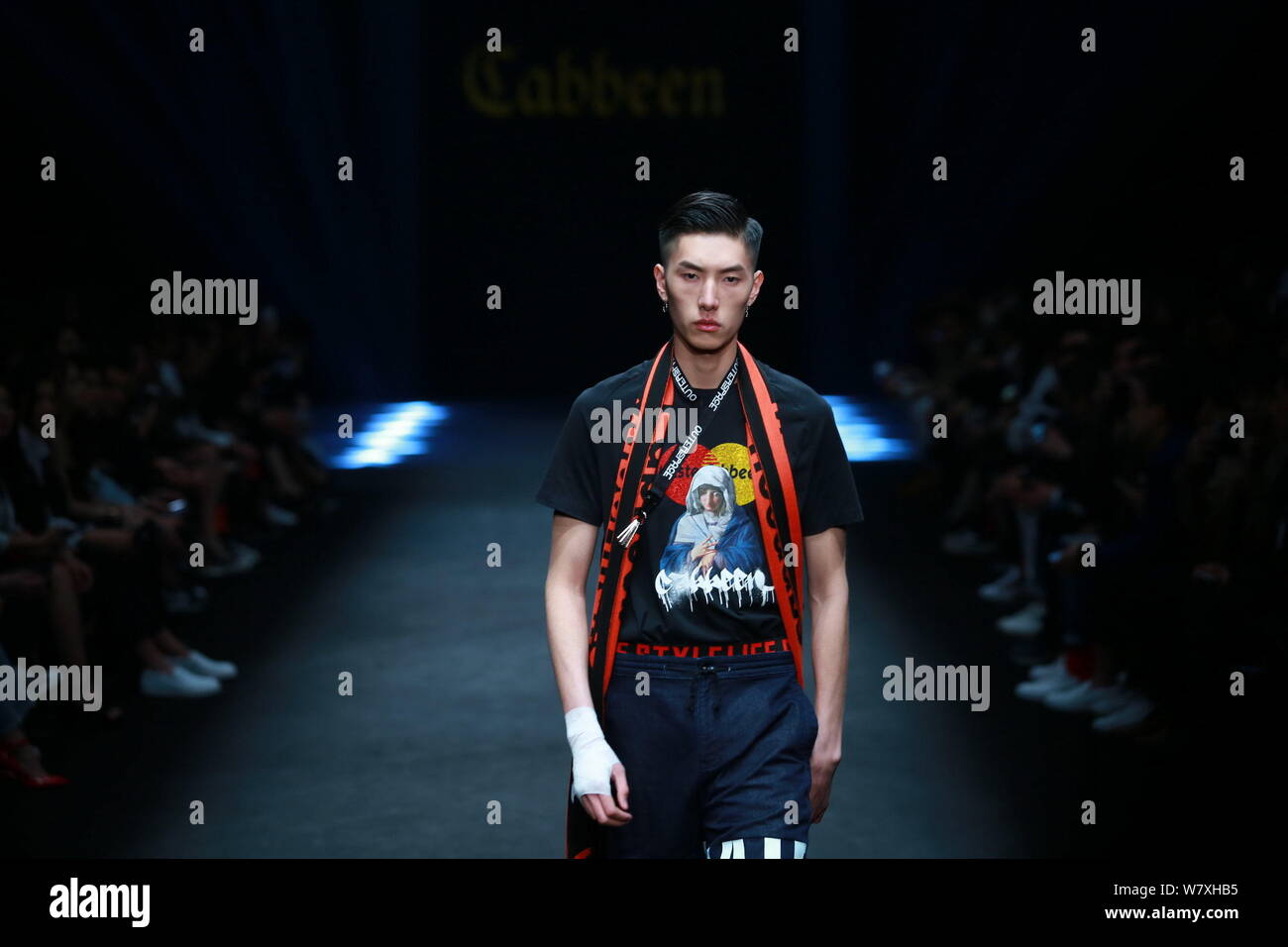 Chinese fencer Dong Li displays a new creation at the fashion show of ...