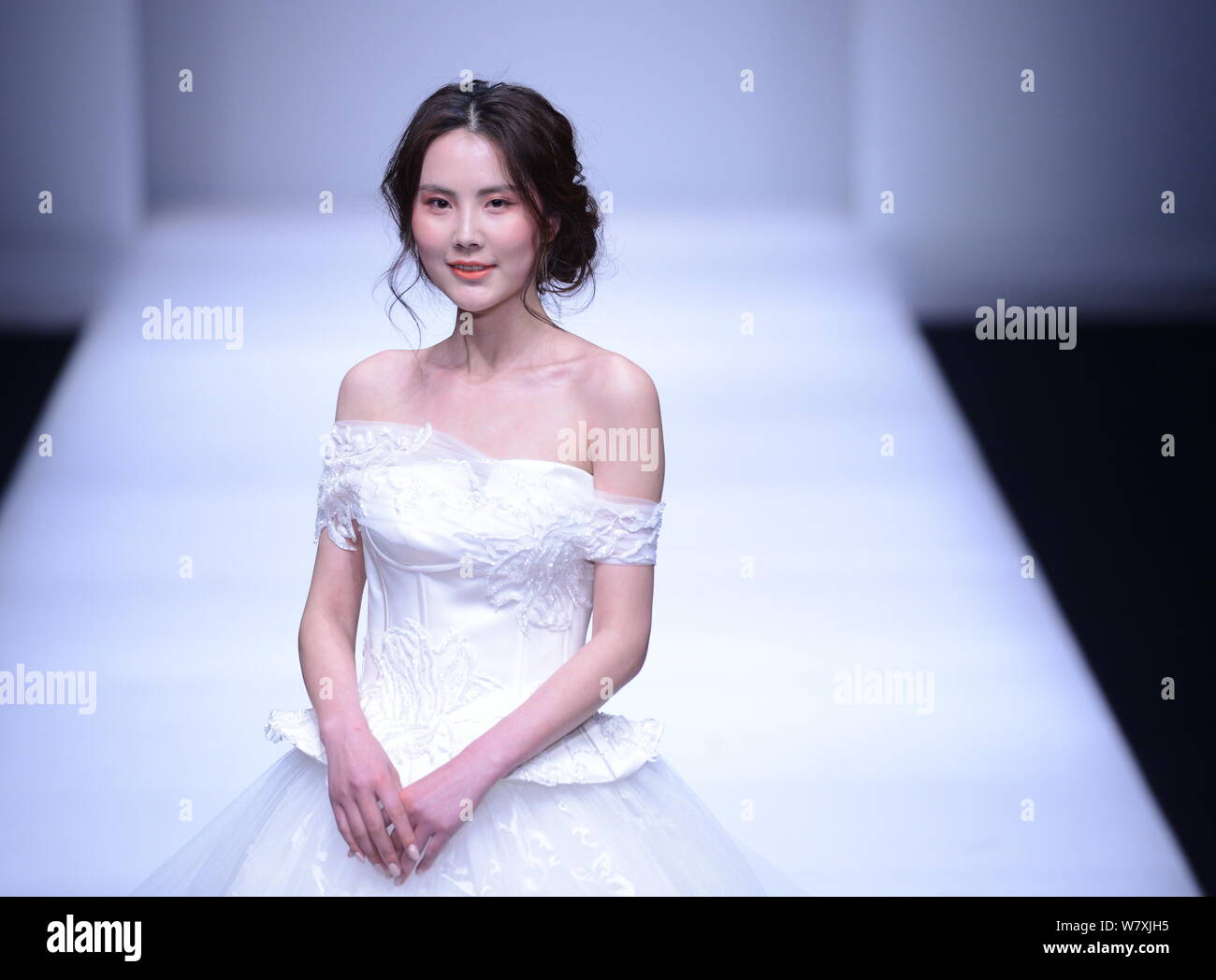 A model displays a new creation at the fashion show of Lian Yu by ...