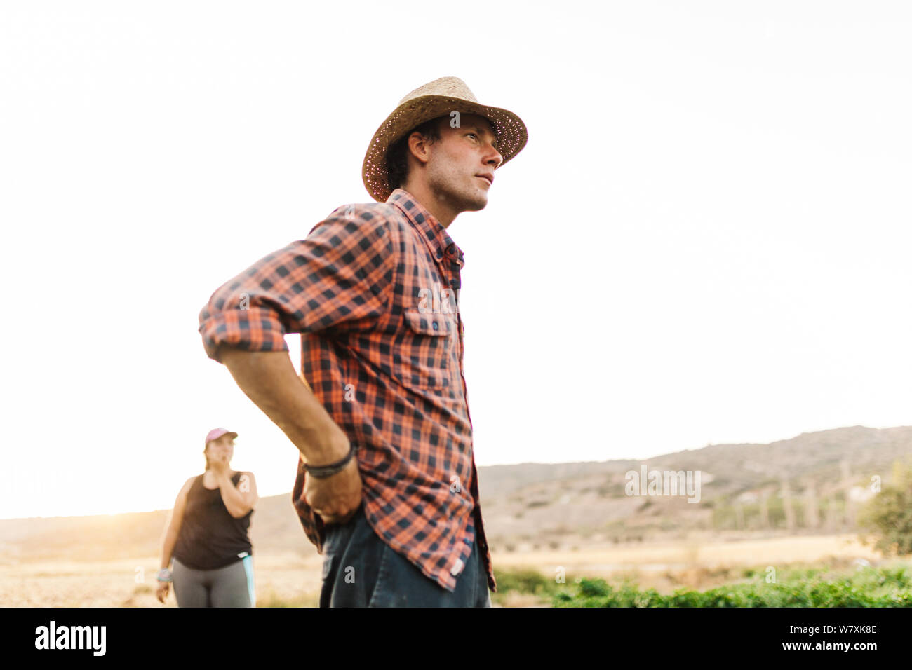 Farmers with hat working in his field Stock Photo - Alamy