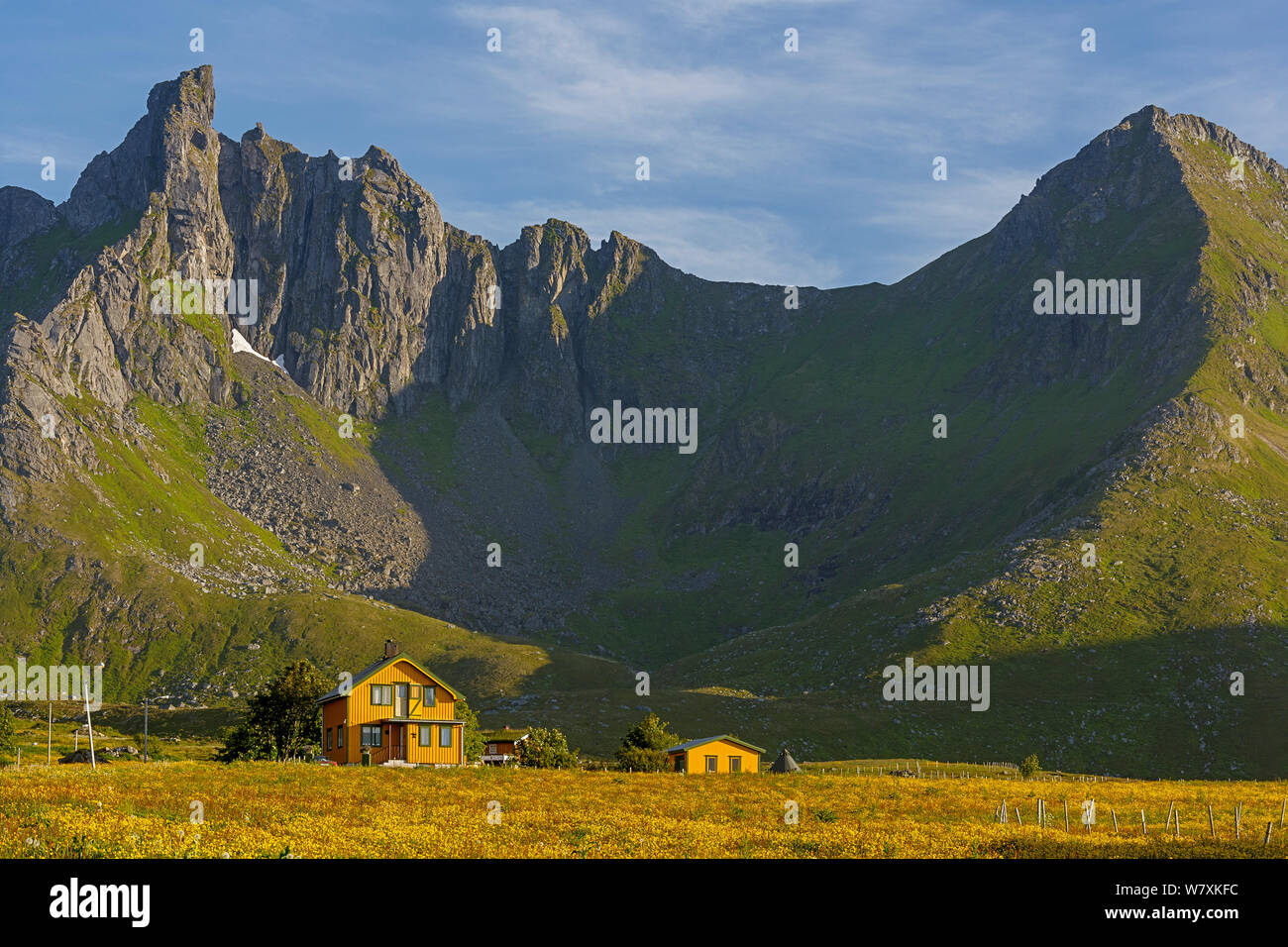 Mountains towering above house at Myrland on the Loften Islands in late ...