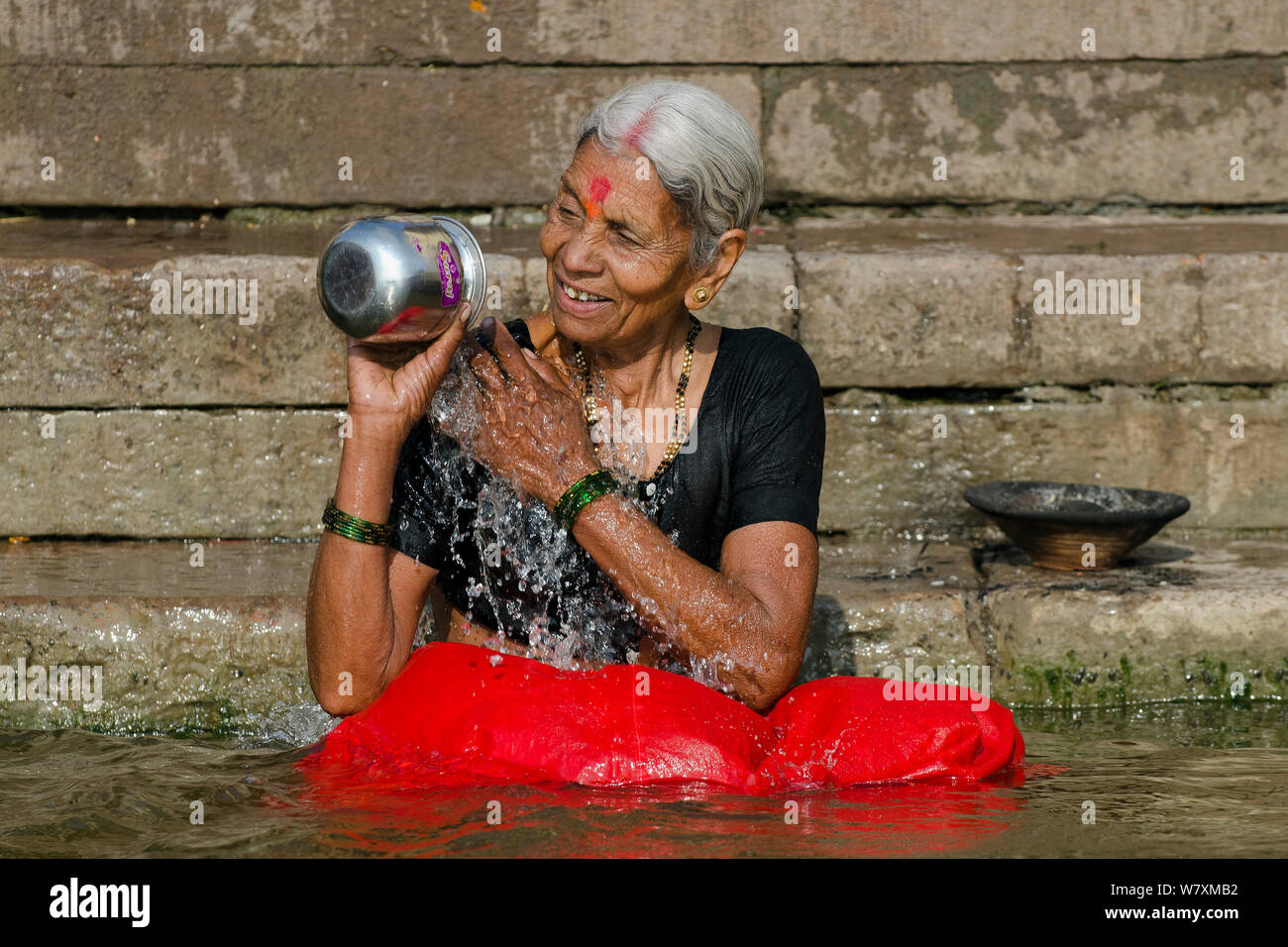 Female pilgrim bathing in the Ganges river, Varanasi, India. February ...