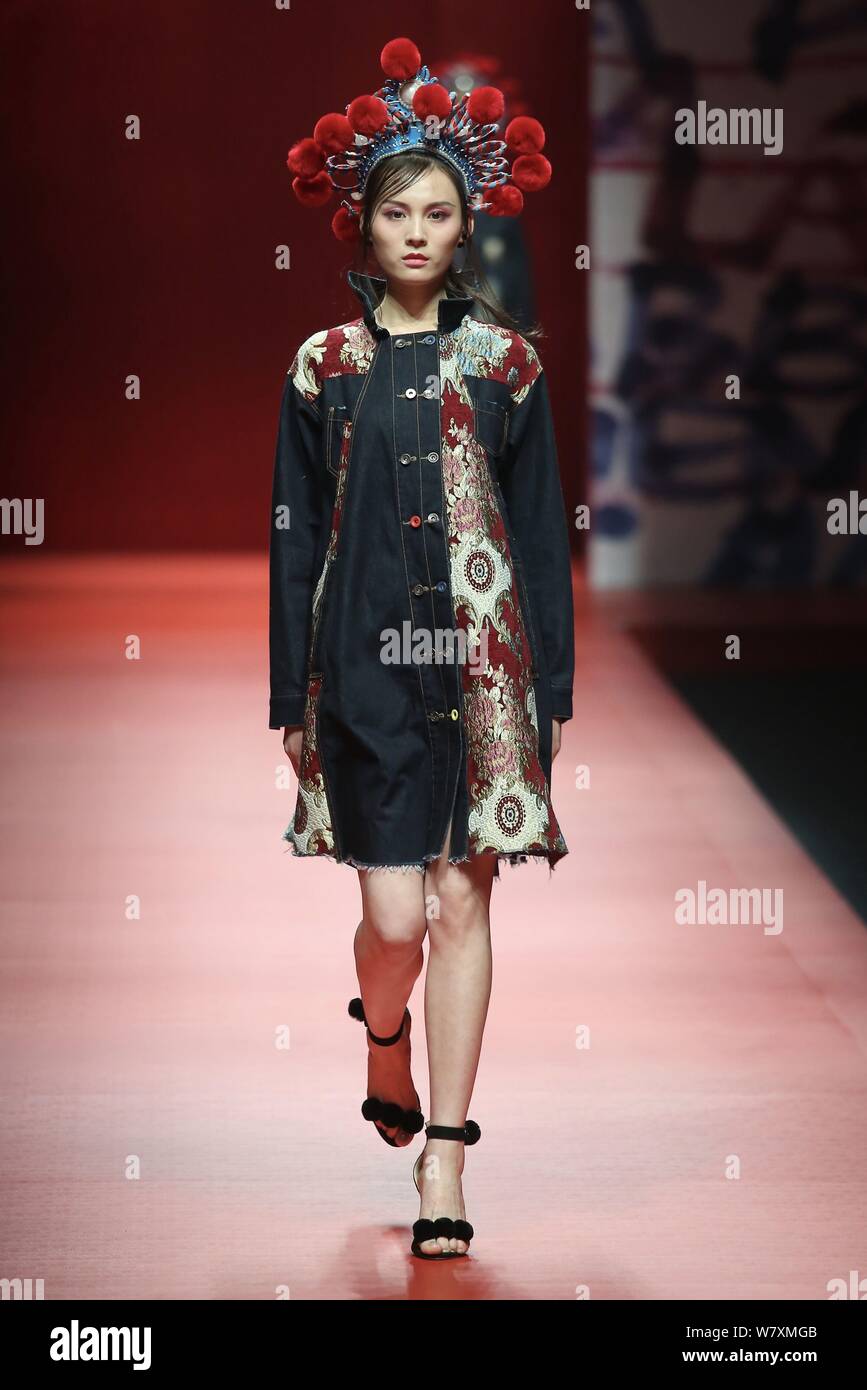 A model displays a new creation at the fashion show of CHENWEN Studio ...