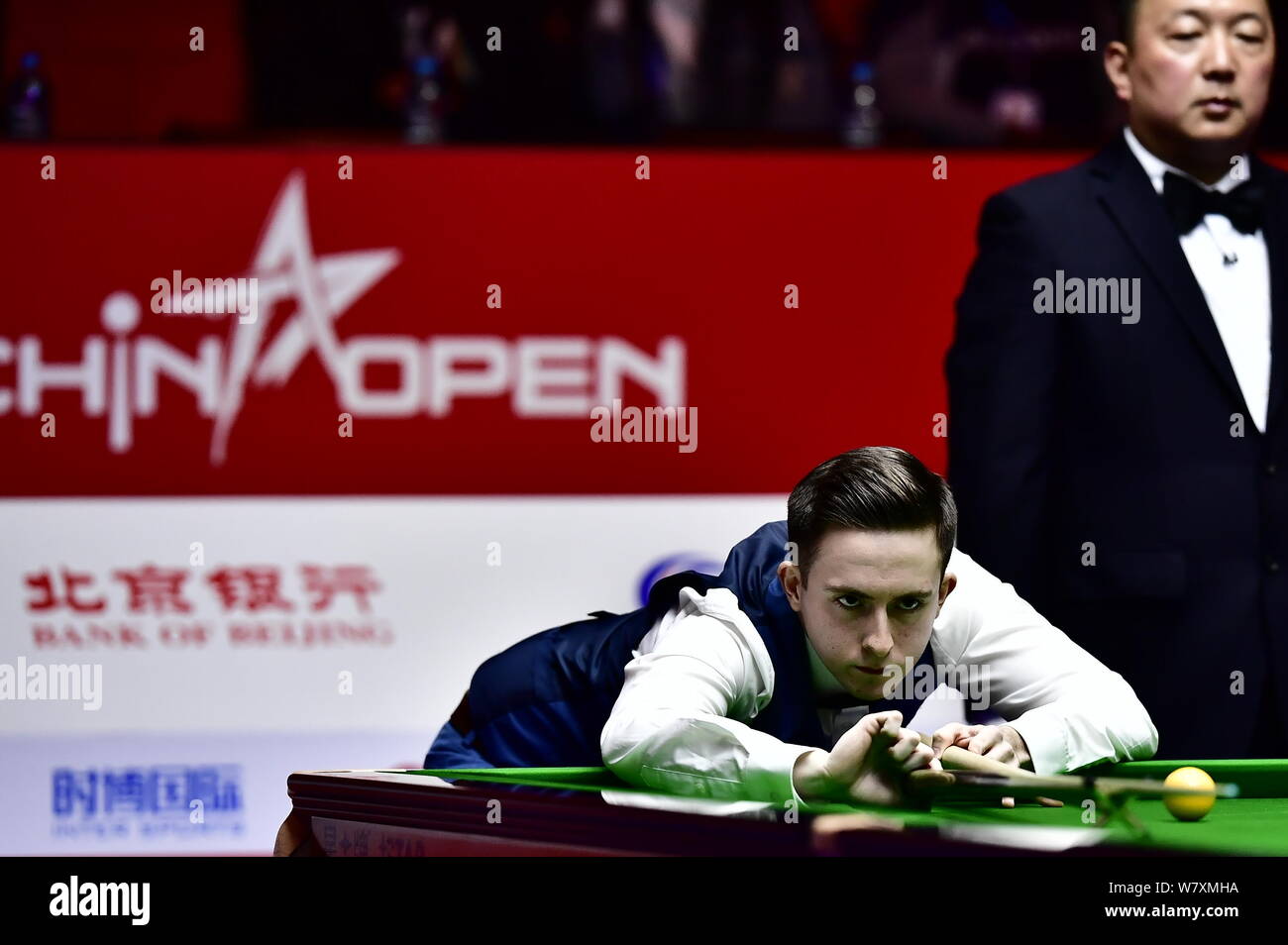 Sean O'Sullivan of England plays a shot to Ding Junhui of China in their qualifying match during ...