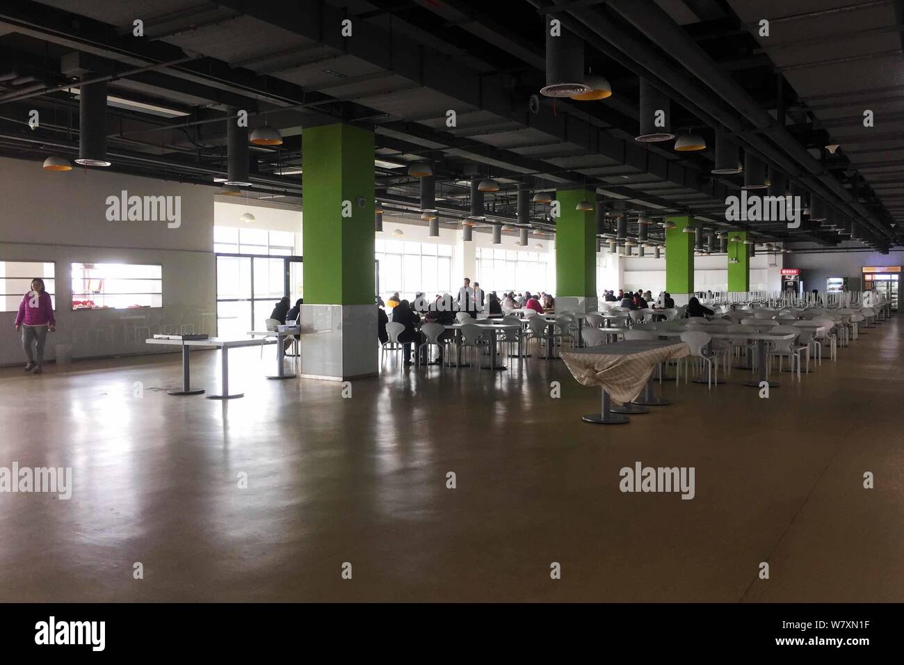 Chinese workers are pictured at a canteen in the Shanghai factory to be ...