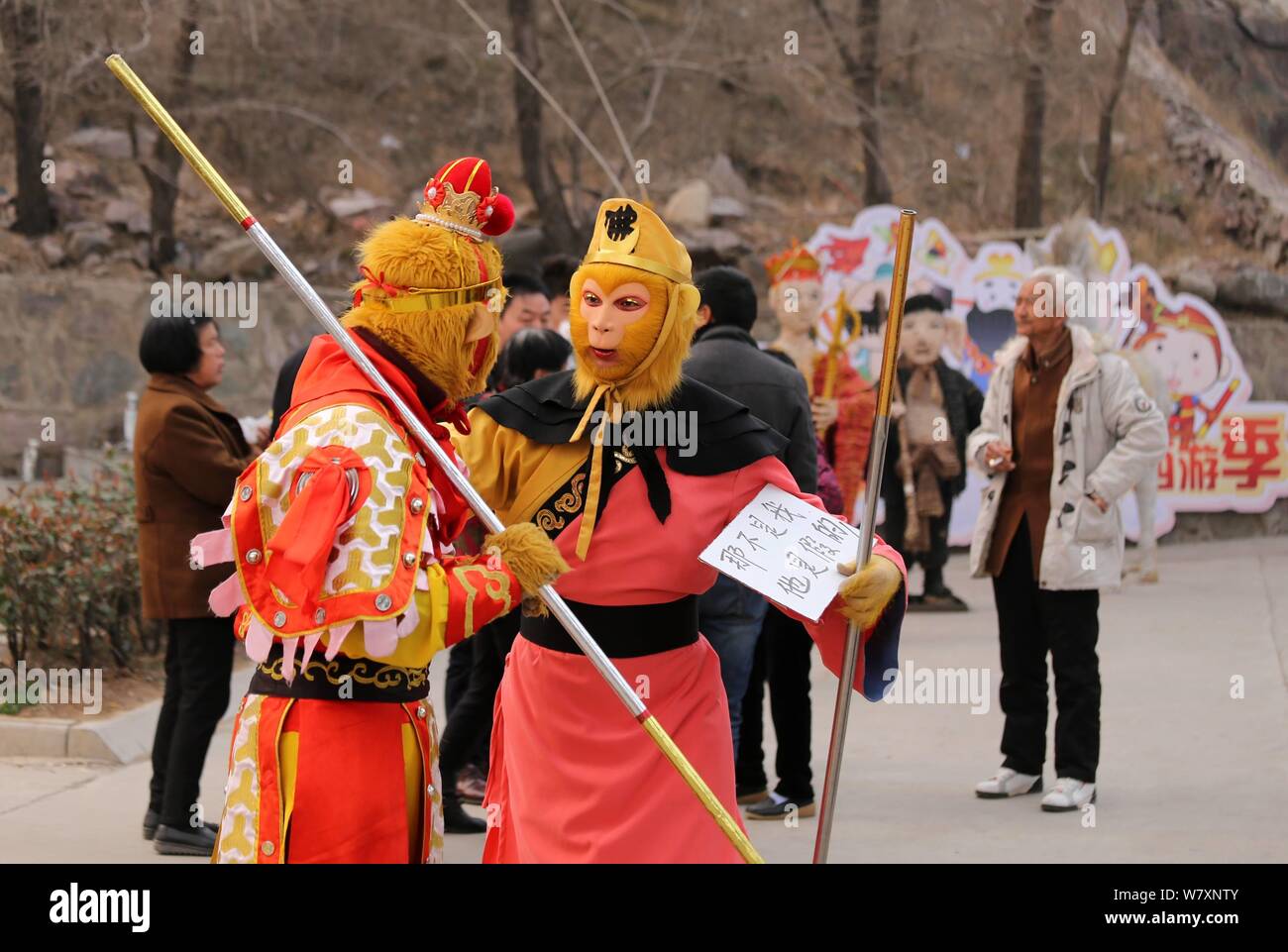 The "Monkey King" bus driver, right, holding a board writing "That's ...