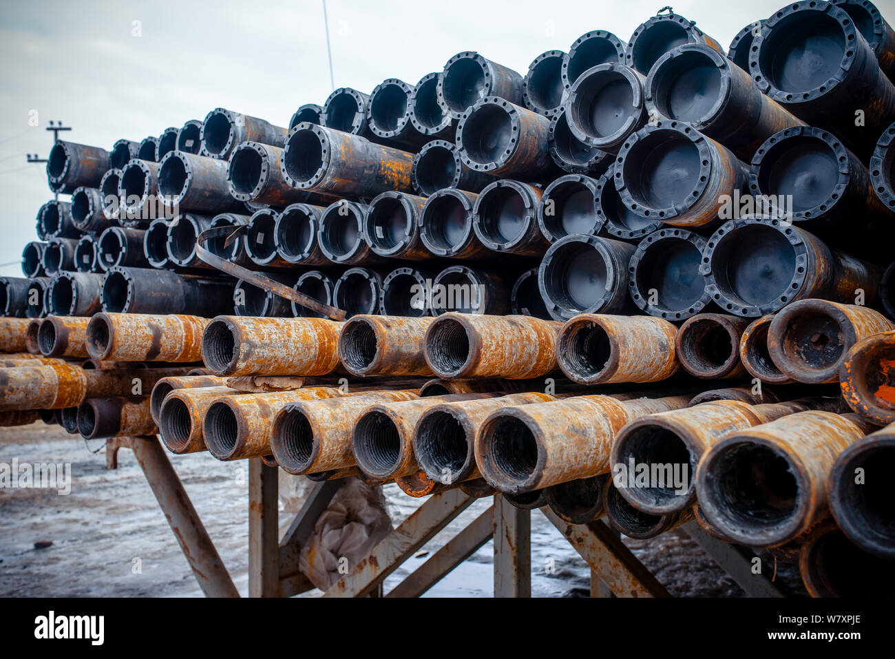 Drill pipe of oil drilling platforms. Stack of oil well casing bundles ...