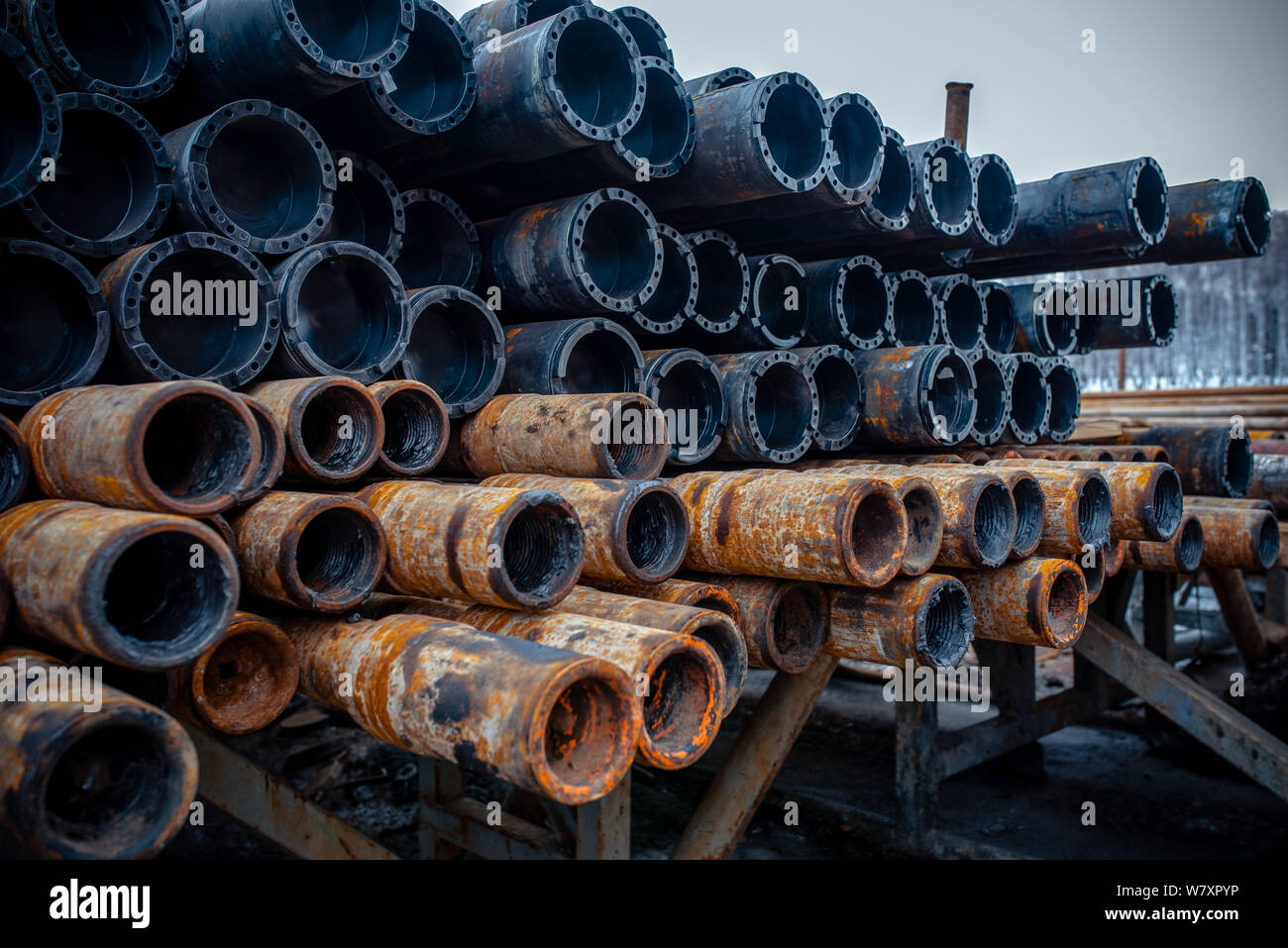 Drill pipe of oil drilling platforms. Stack of oil well casing bundles ...