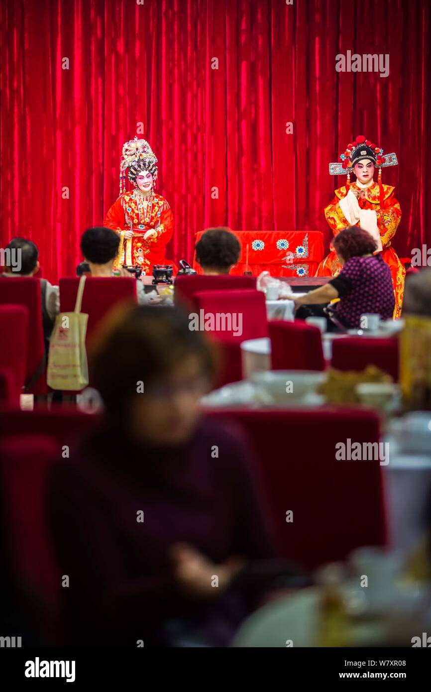 Chinese audience watch Yueju Opera artists performing at a stage in ...