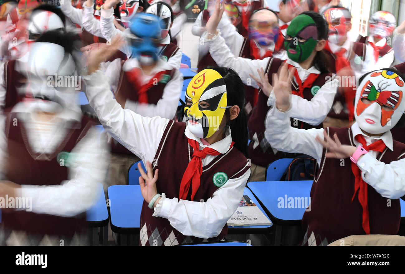 Chinese pupils wearing Chinese opera facial pose for photos in a ...