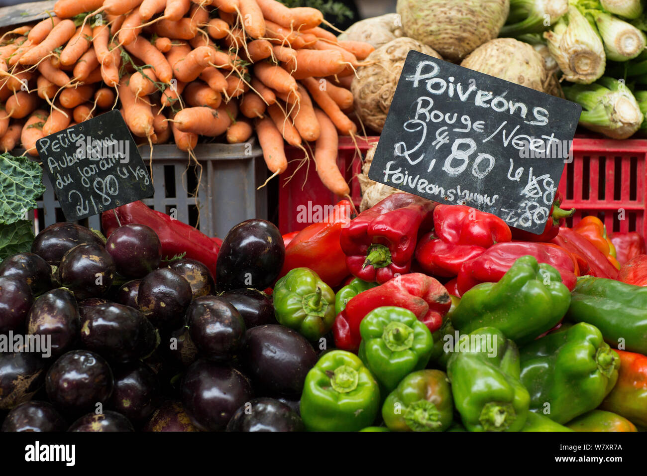 Vegetables including peppers, aubergines, carrots and celery at market ...
