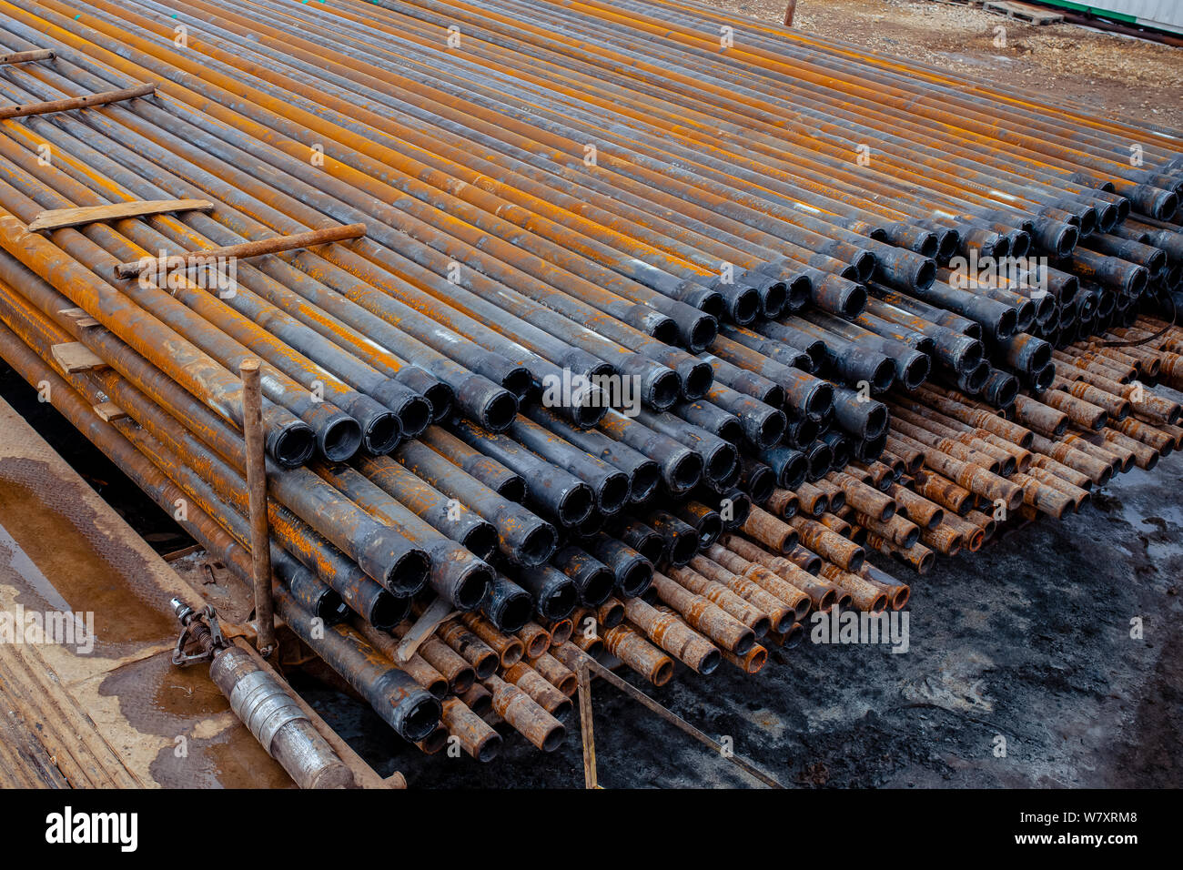 Drill pipe of oil drilling platforms. Stack of oil well casing bundles ...