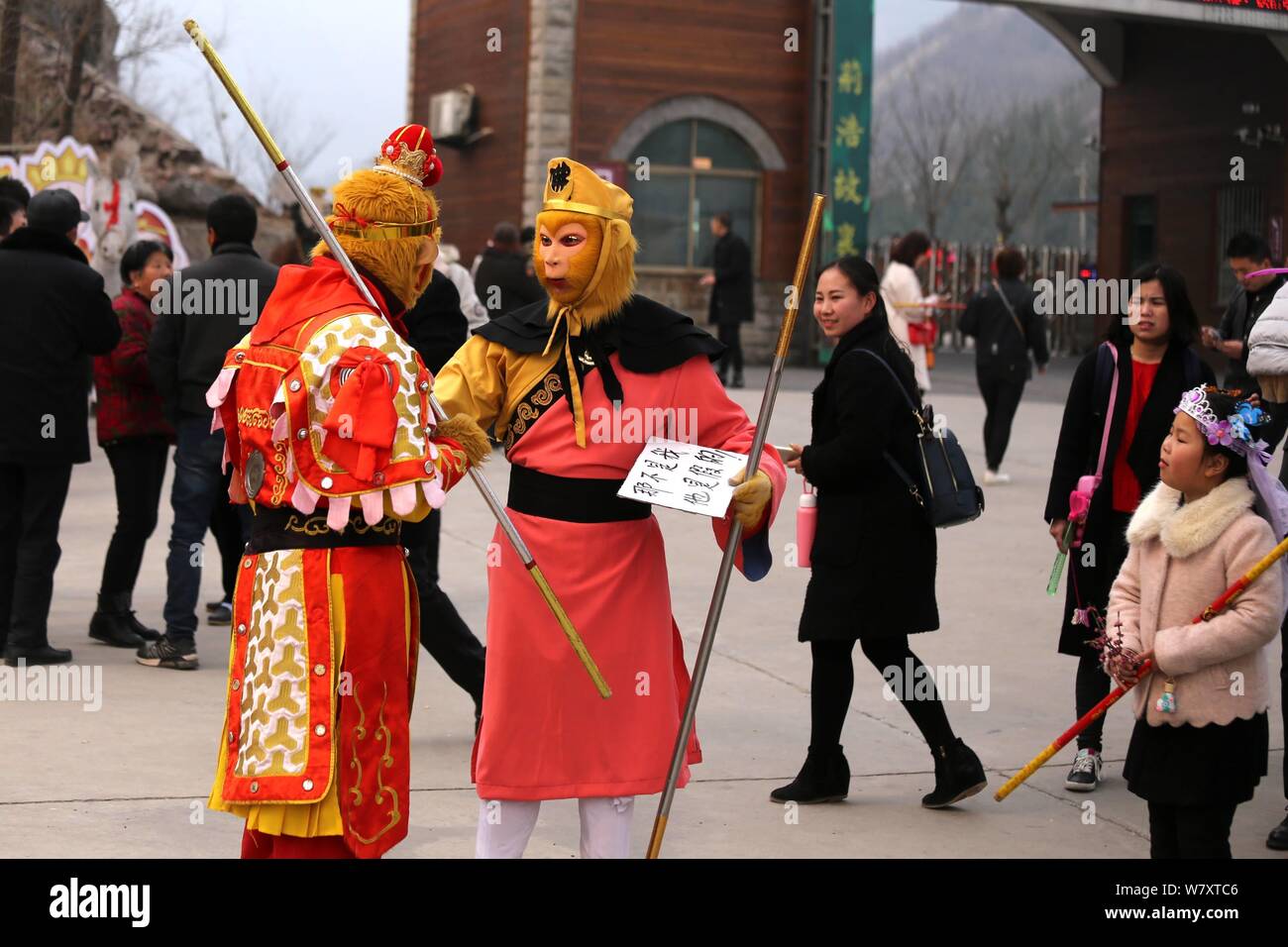 The "Monkey King" bus driver, right, holding a board writing "That's ...