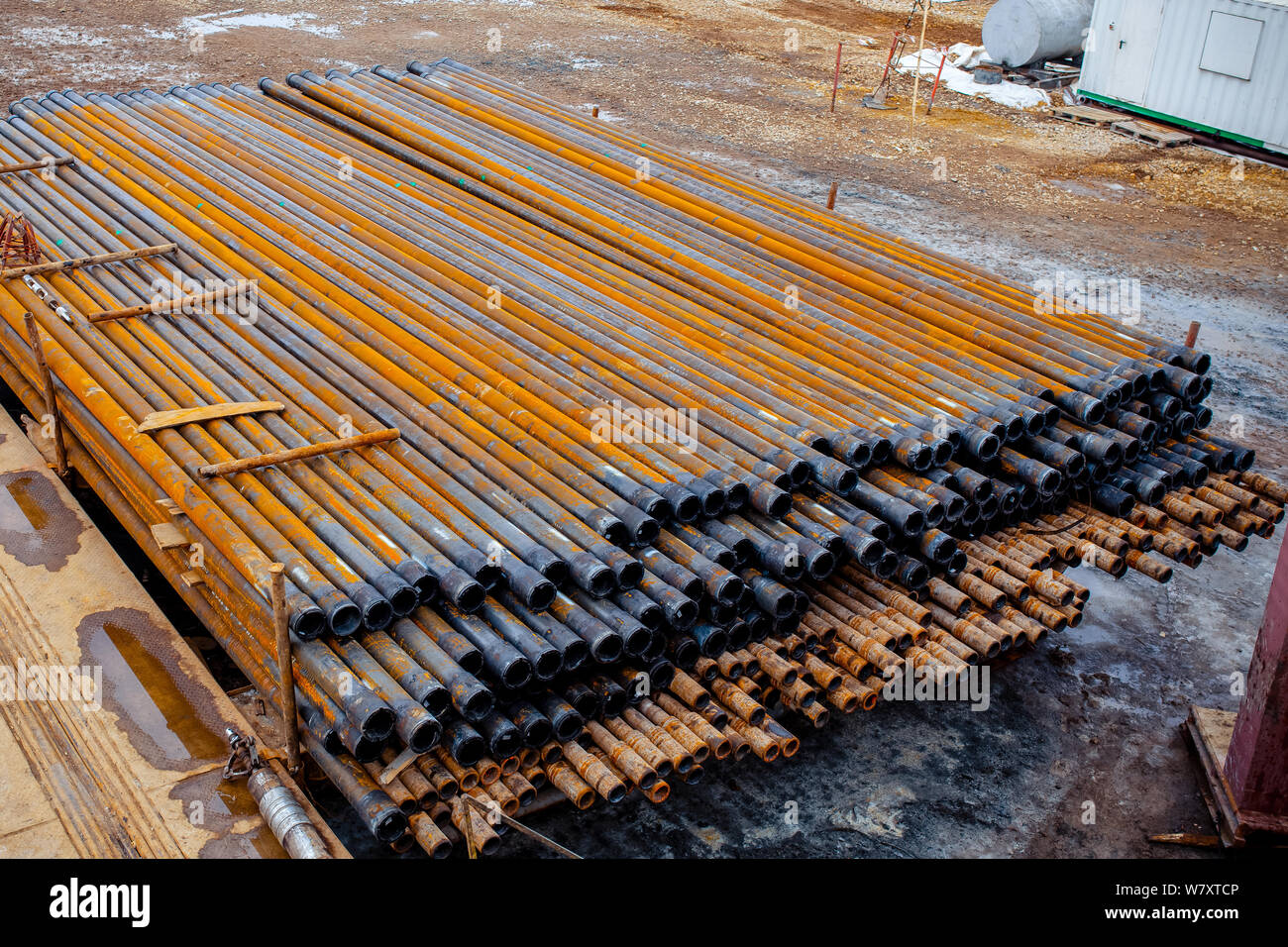 Drill pipe of oil drilling platforms. Stack of oil well casing bundles ...