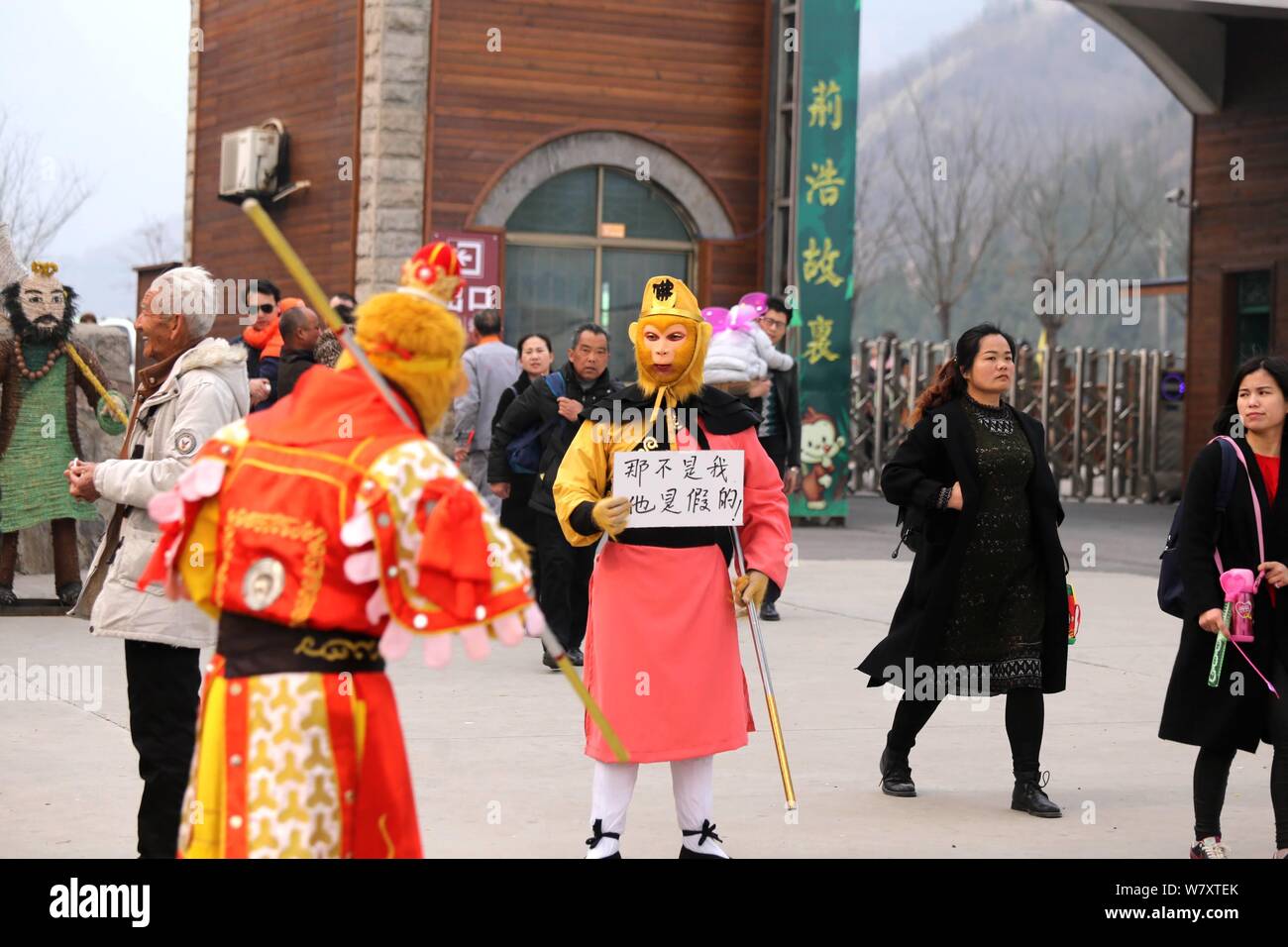 The "Monkey King" bus driver, right, holding a board writing "That's ...