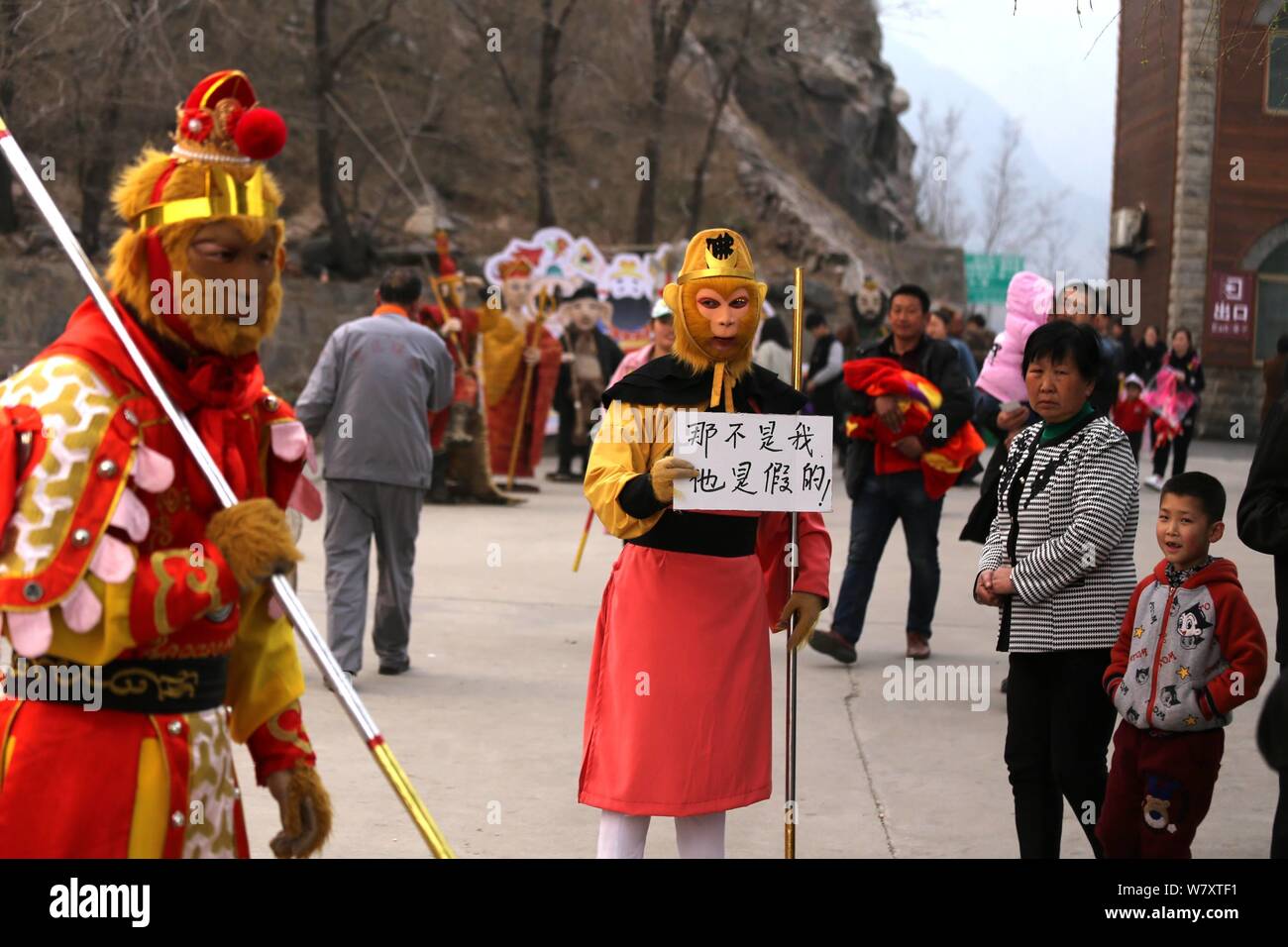 The "Monkey King" bus driver, right, holding a board writing "That's ...