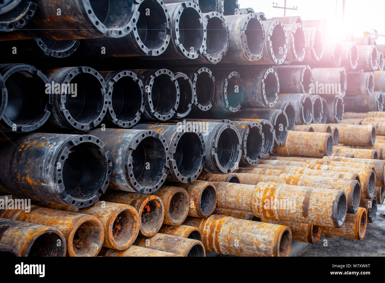 Drill pipe of oil drilling platforms. Stack of oil well casing bundles ...