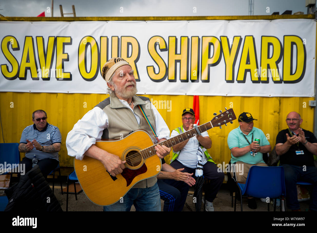Irish singer songwriter Tommy Sands performing at the gates of Harland ...