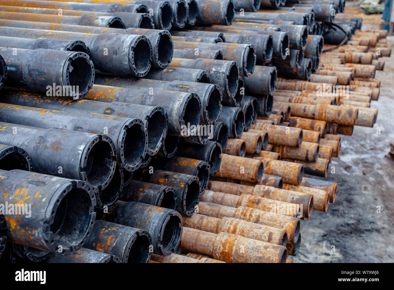 Drill pipe of oil drilling platforms. Stack of oil well casing bundles ...