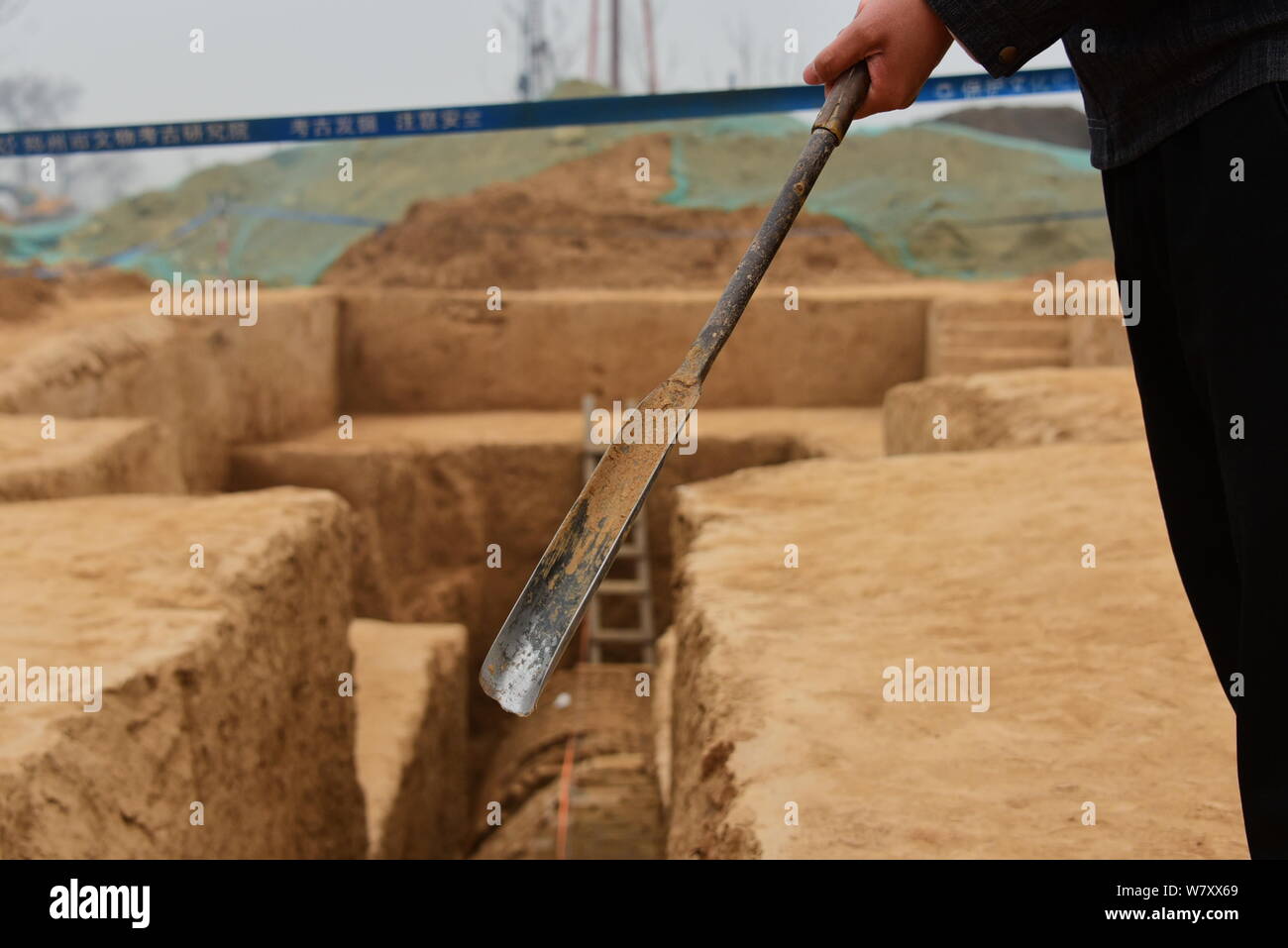 A Chinese archaeologist shows his tool to unearth a coffin chamber ...