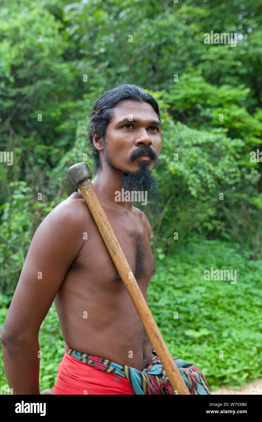 Portrait of Vedda tribesman carrying axe, Dambana, Sri Lanka, December ...