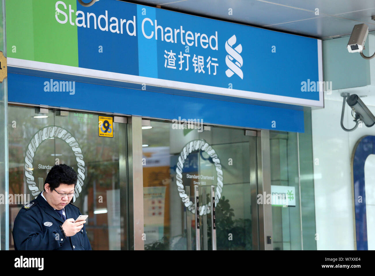 --FILE--A pedestrian walks past a branch of London-listed Standard ...
