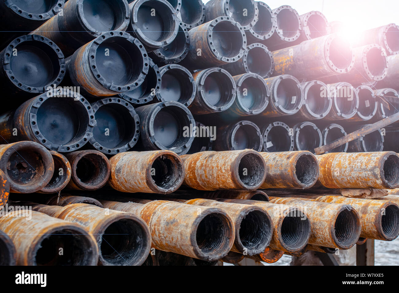 Drill pipe of oil drilling platforms. Stack of oil well casing bundles ...