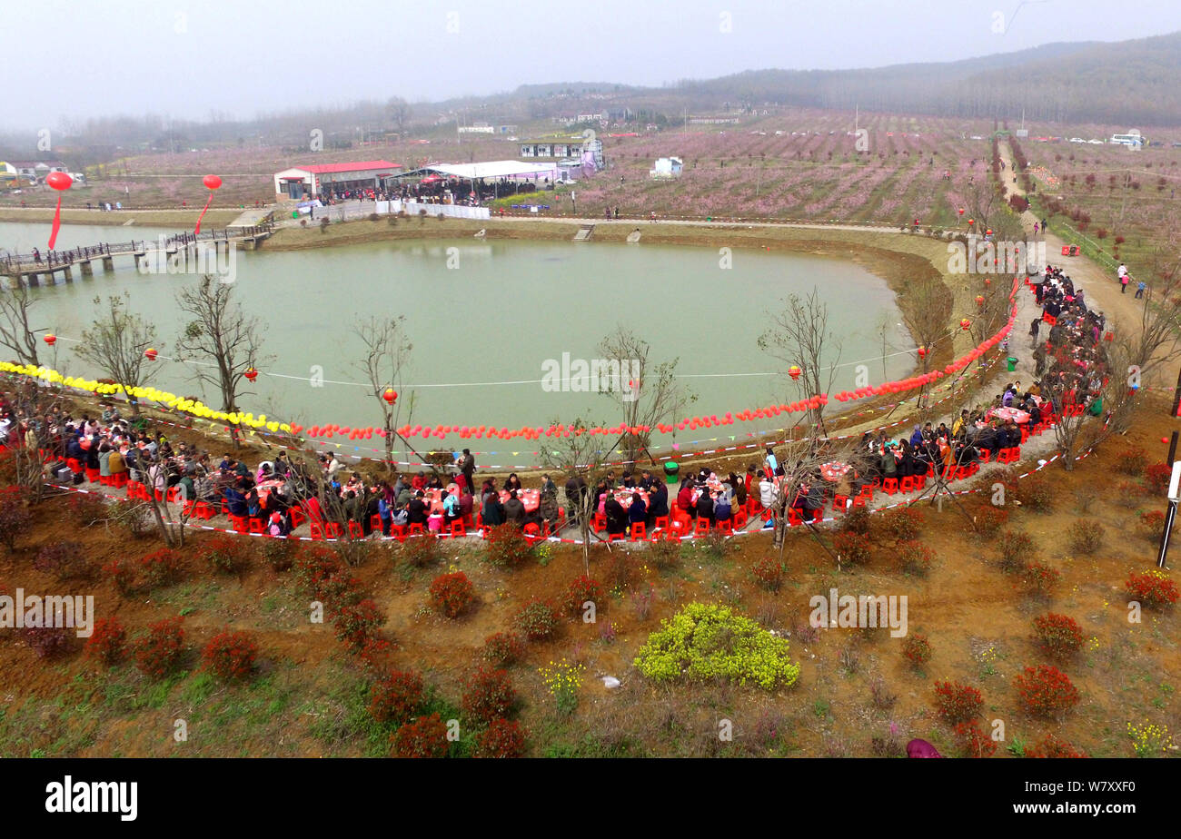 Chinese tourists are seen at the open-air banquet hosting 150 tables of ...