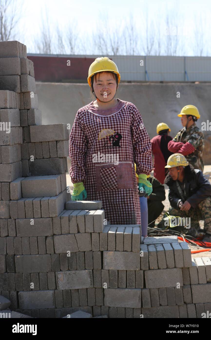 Female Chinese mason Yang Jianhua, 32, from Chongqing, poses for a ...