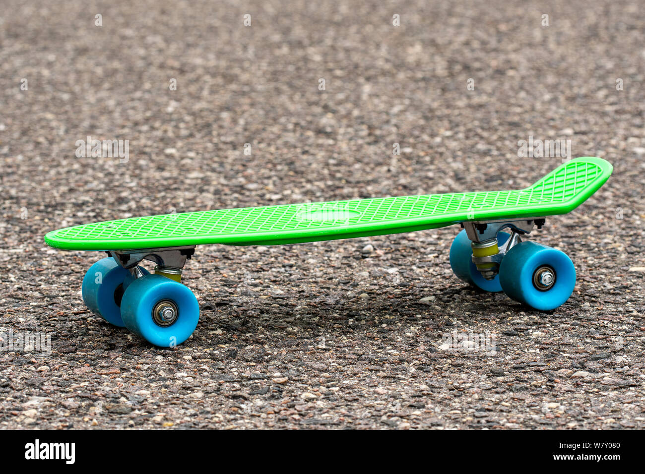 Green skateboard on the asphalt road Stock Photo - Alamy