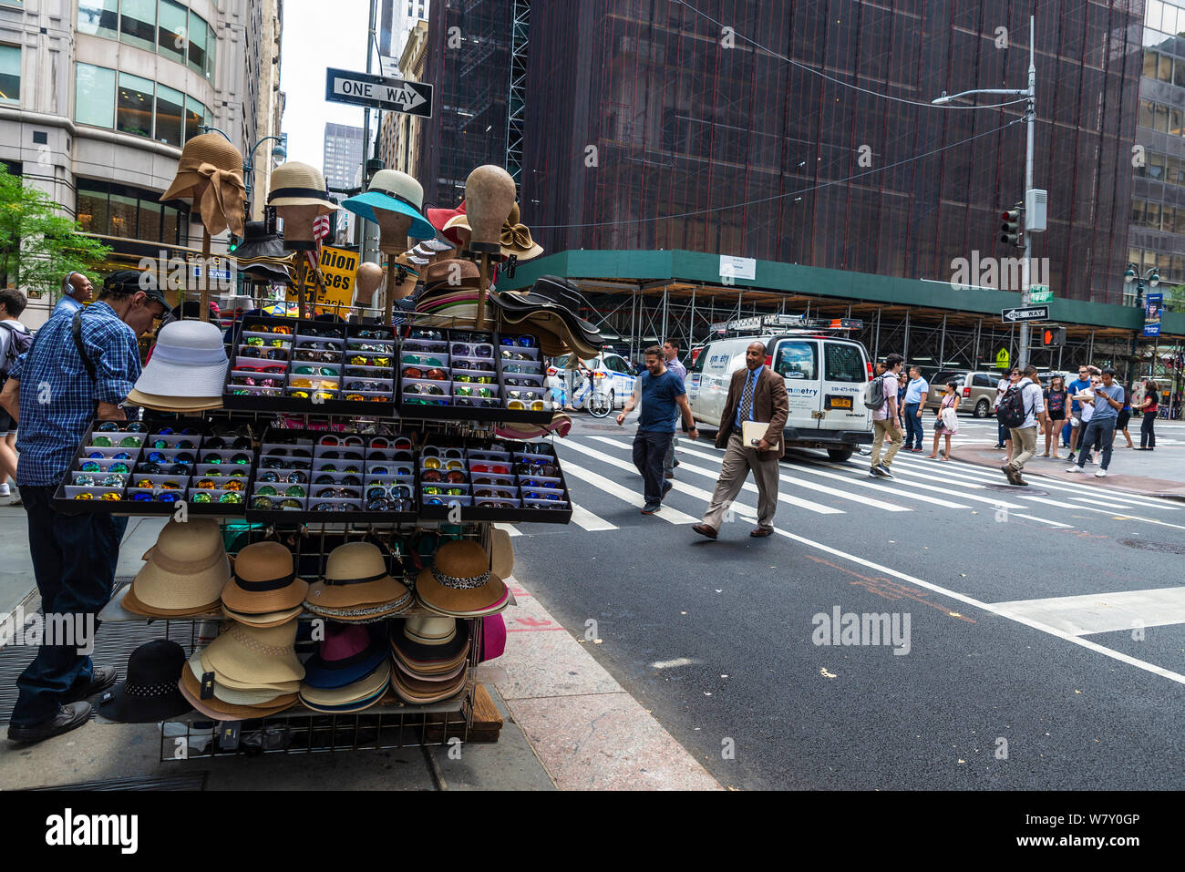 New York City, USA - August 2, 2018: Seller at his stall selling hats ...