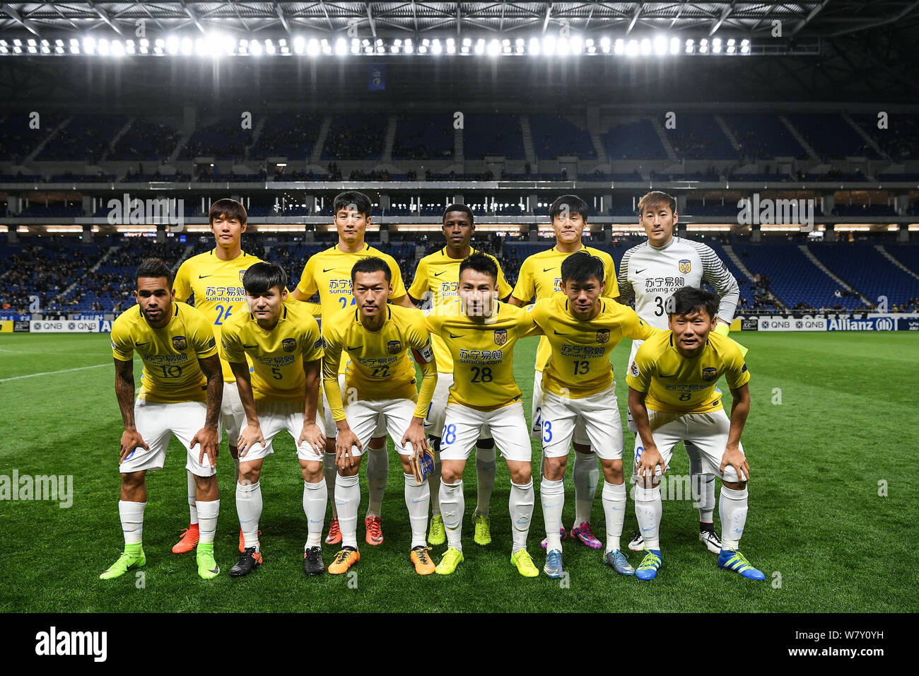 Players of the starting line-up of China's Jiangsu Suning pose before ...