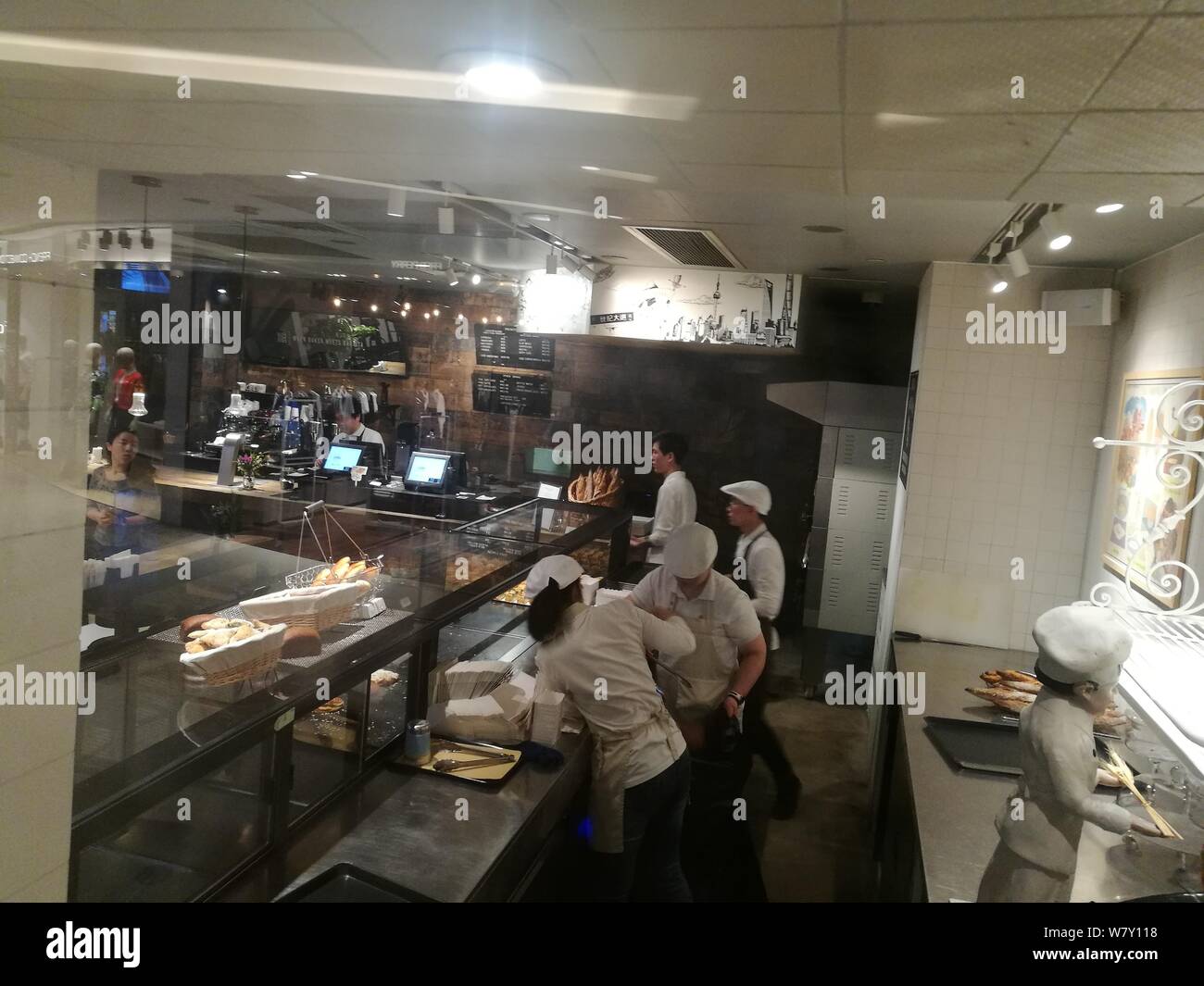 Chinese workers remove bread off shelves at a chain store of French ...