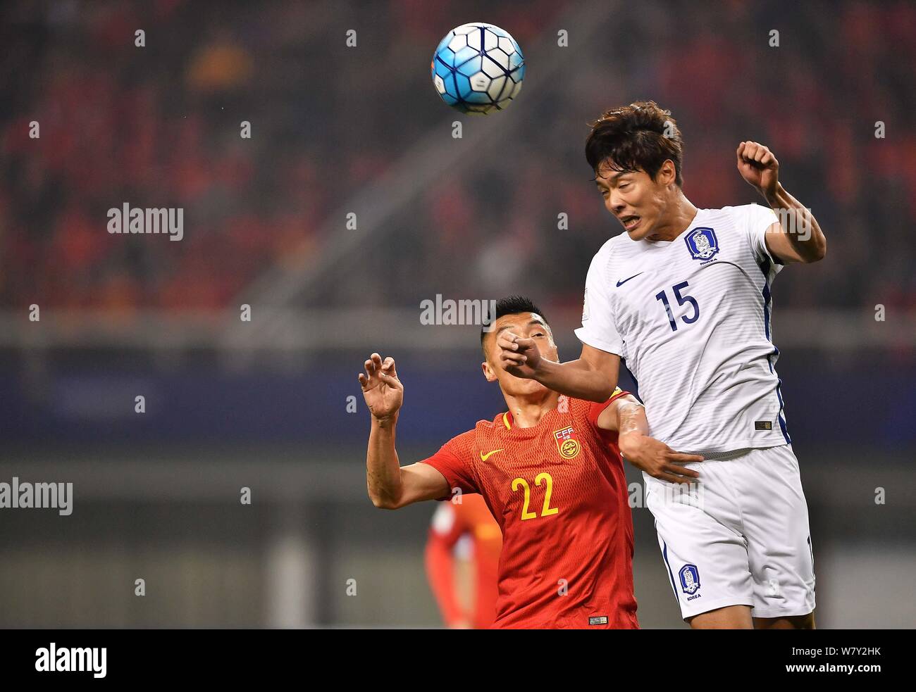 Yu Dabao of Chinese national men's football team challenges Hong Jeong ...