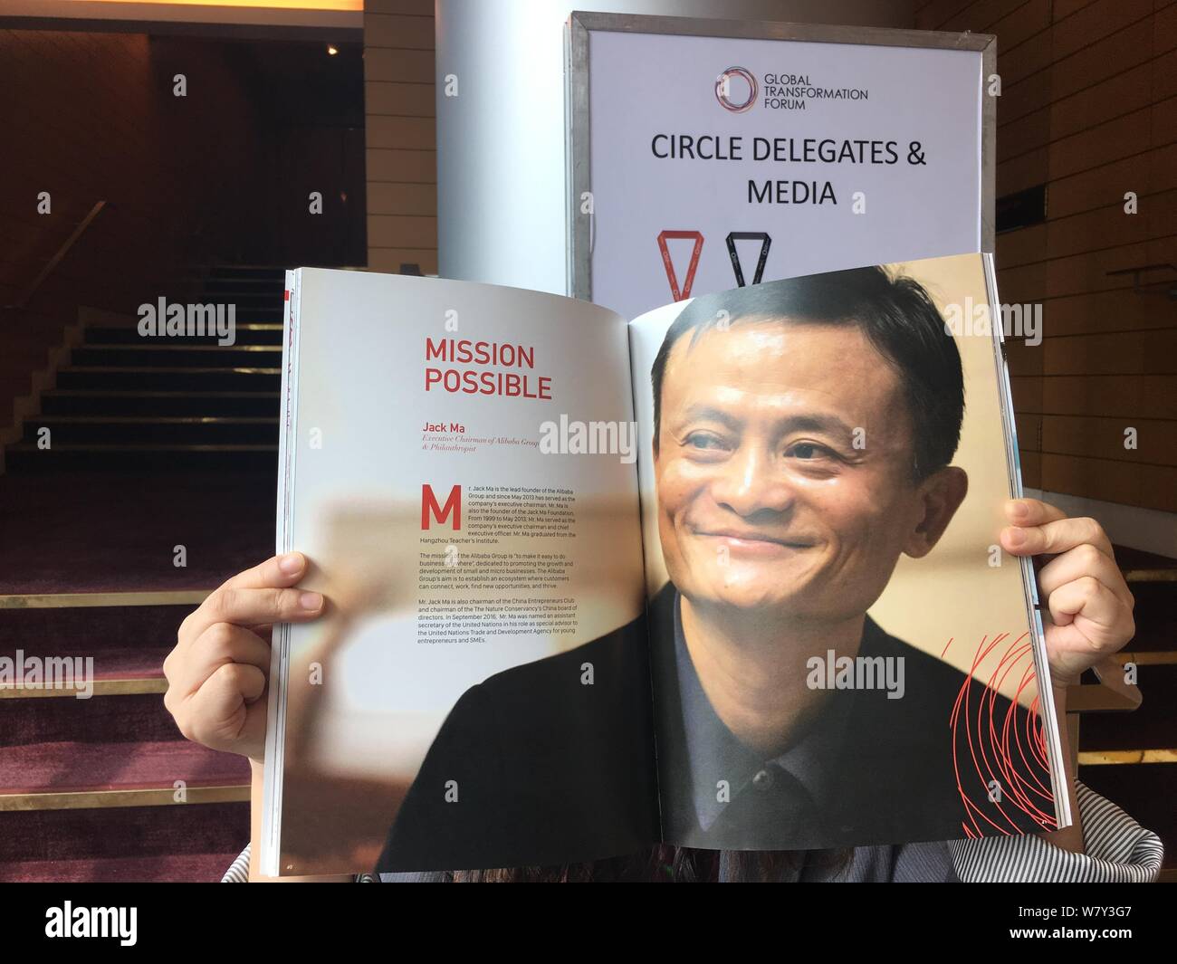 --FILE--A visitor shows a picture of Jack Ma or Ma Yun, chairman of ...
