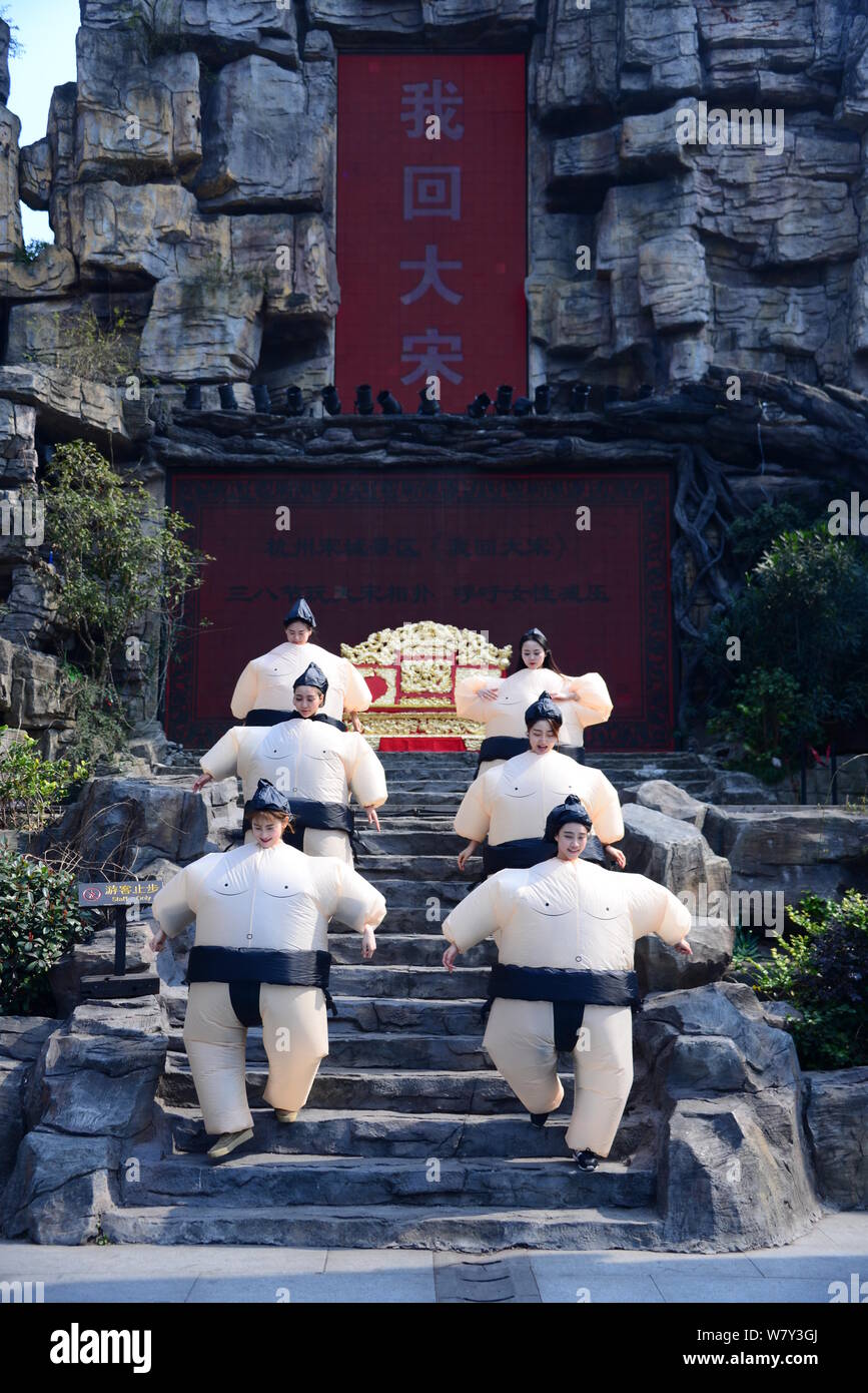 Chinese women dressed in inflatable sumo-wrestler costumes pose at ...